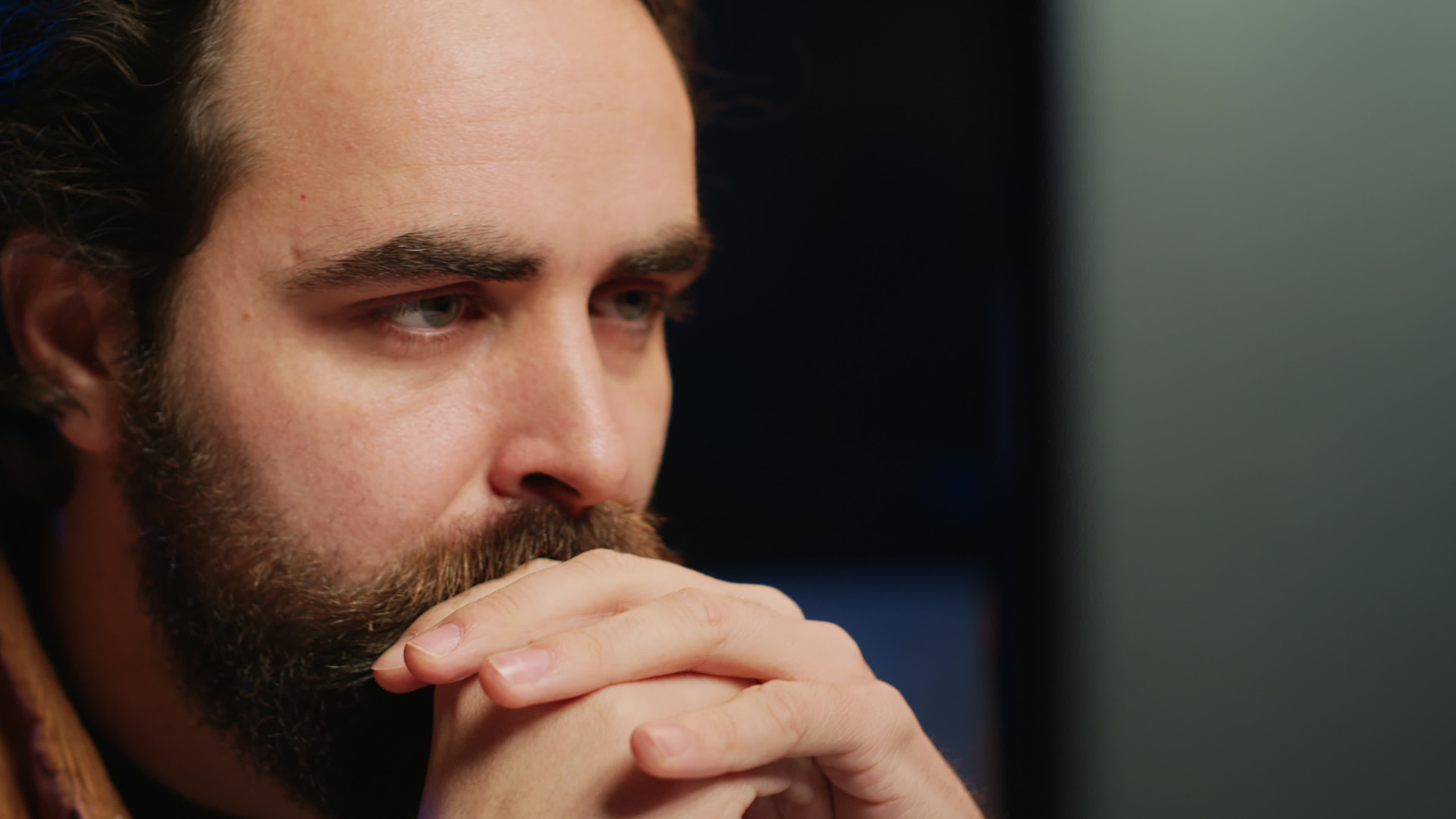 Programmer in home office concentrating on finding bugs while doing coding on computer, extreme ...