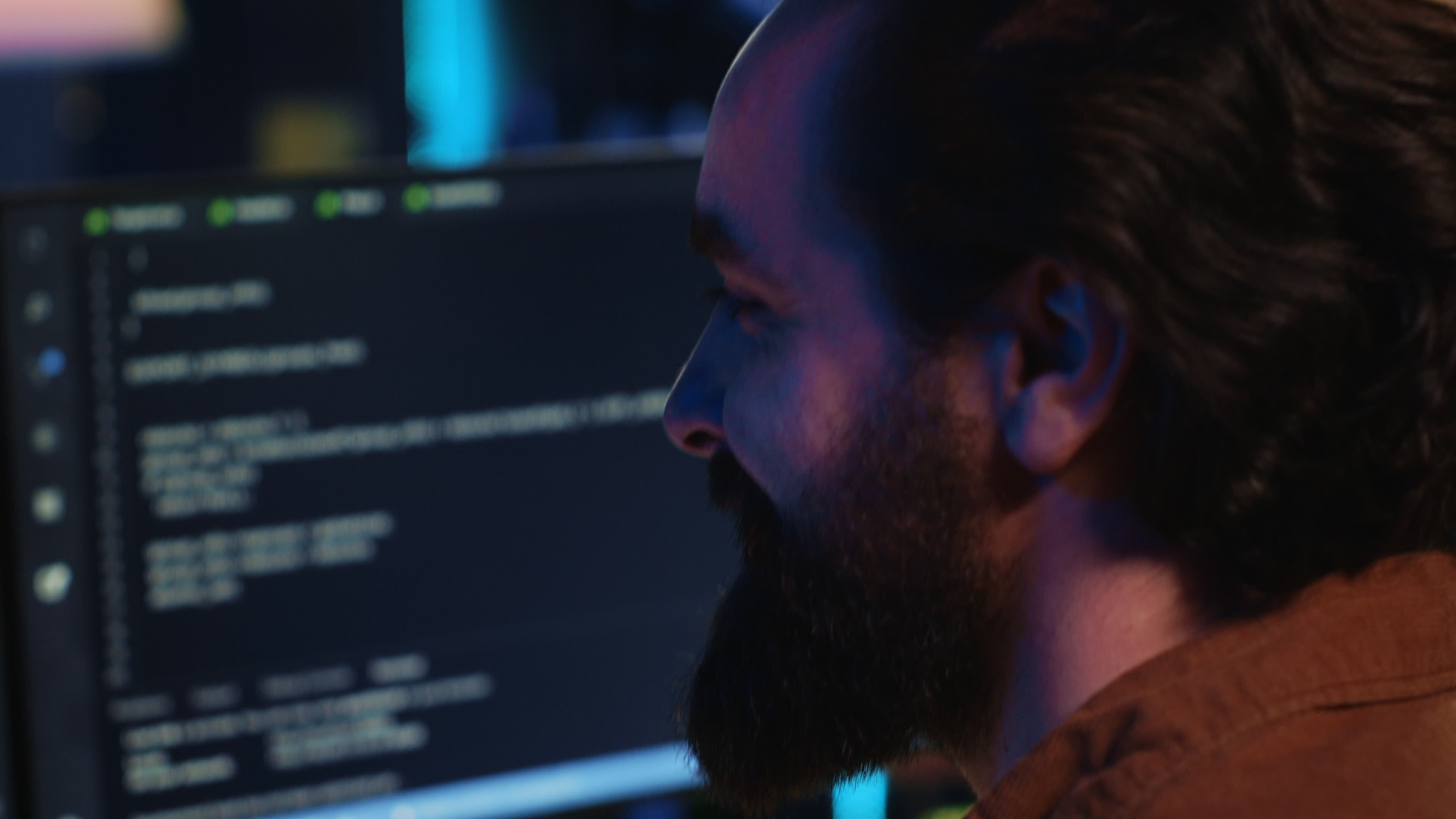 Joyous remotely working programmer in home office doing coding on ...