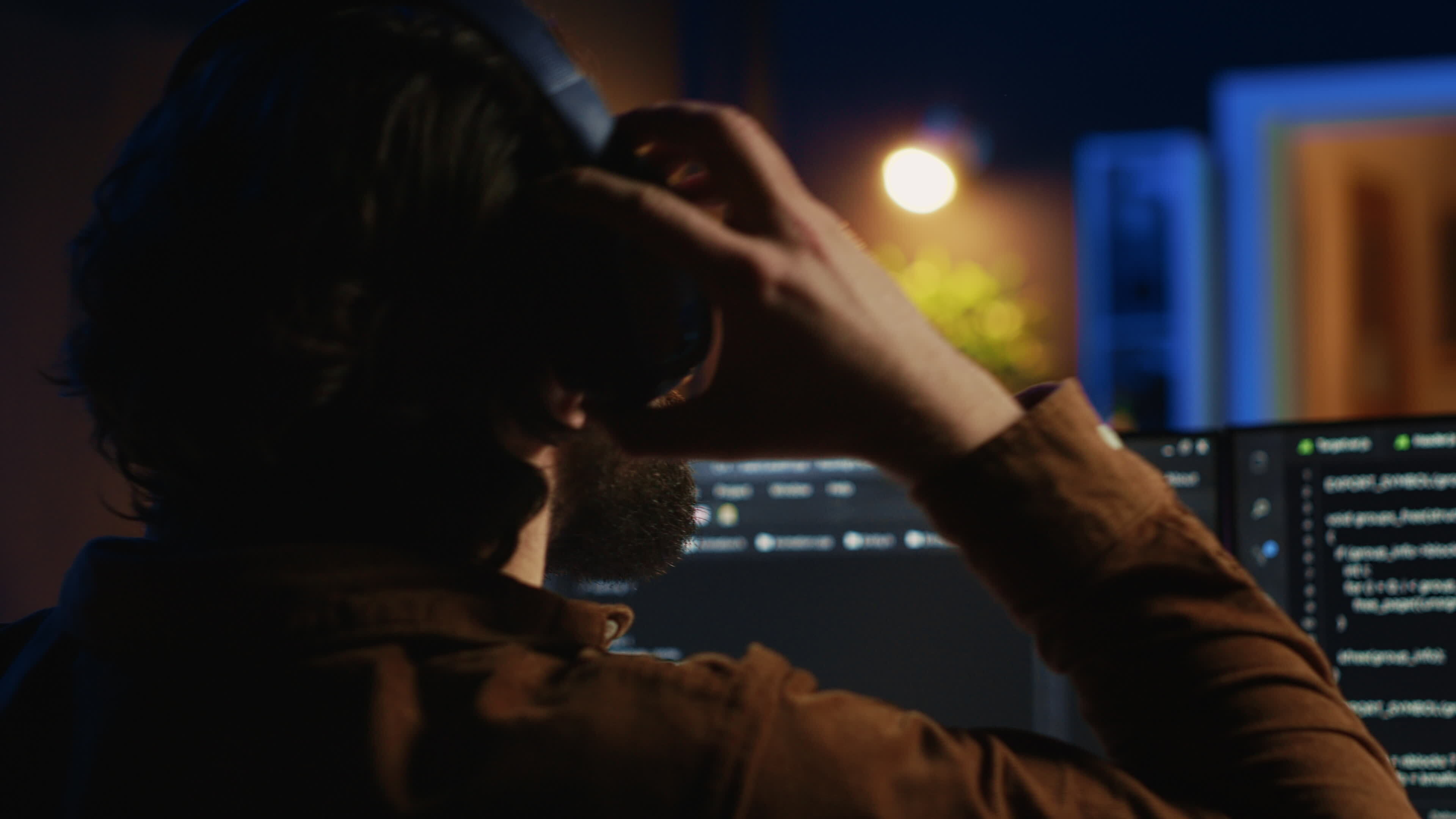 Technician Putting Headphones On While Using Coding To Fortify Firewalls Teleworking For It