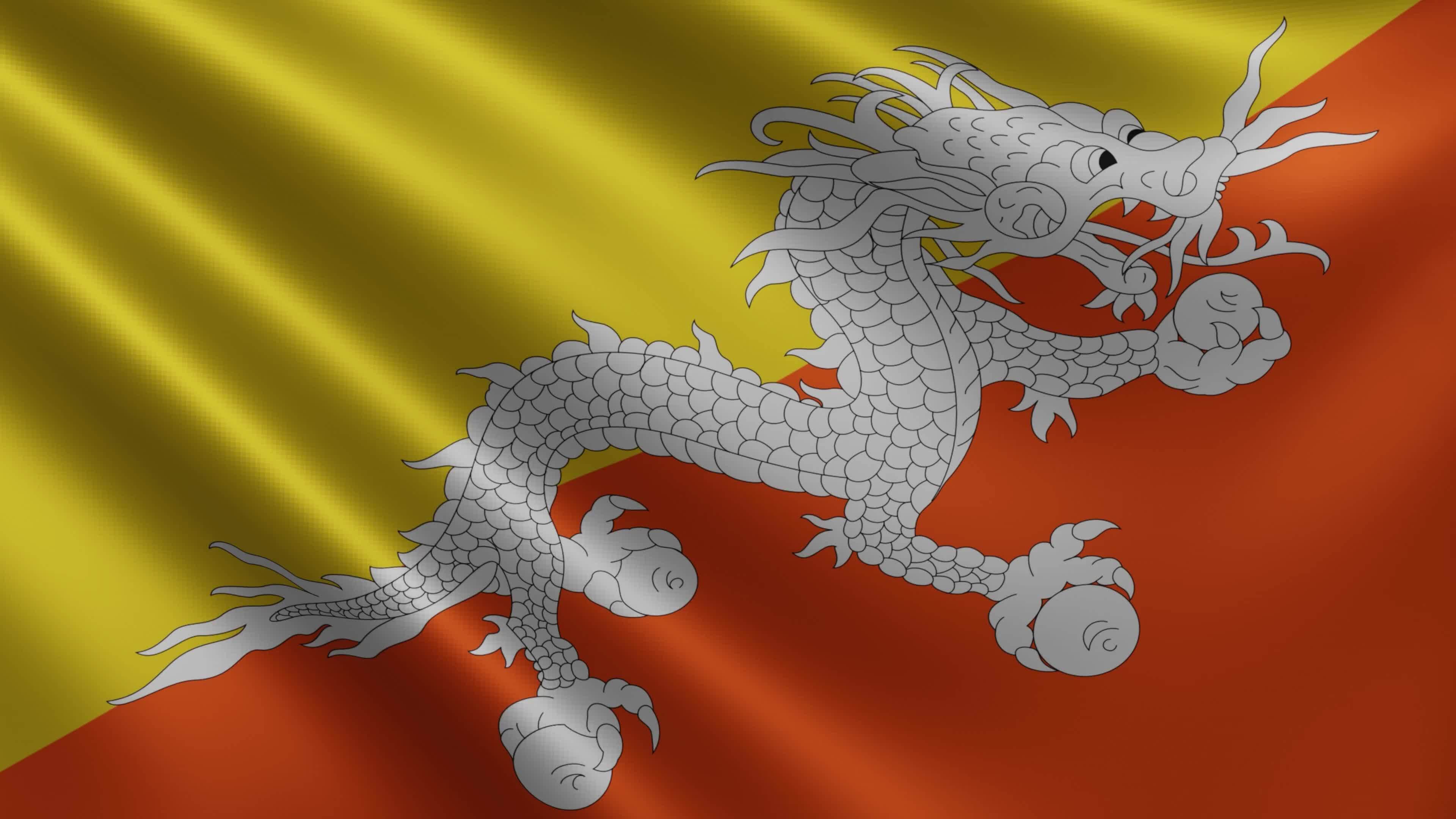 The flag of Bhutan is flying in the wind close-up, the national flag of ...