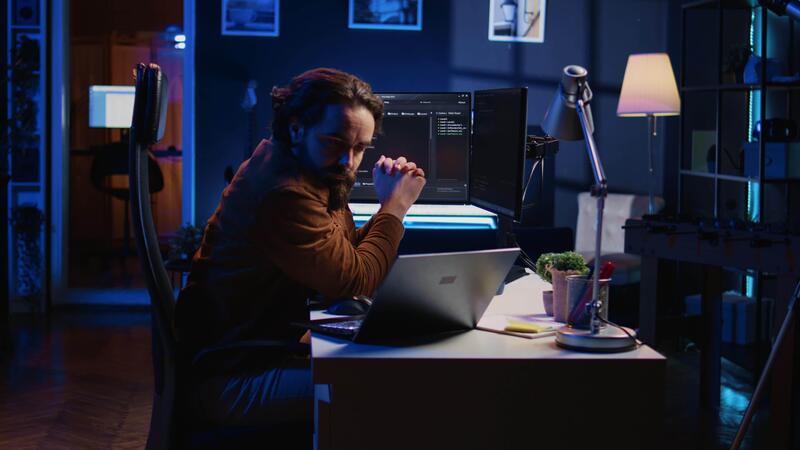 Software Programmer Putting Headphones On While Developing Code Making