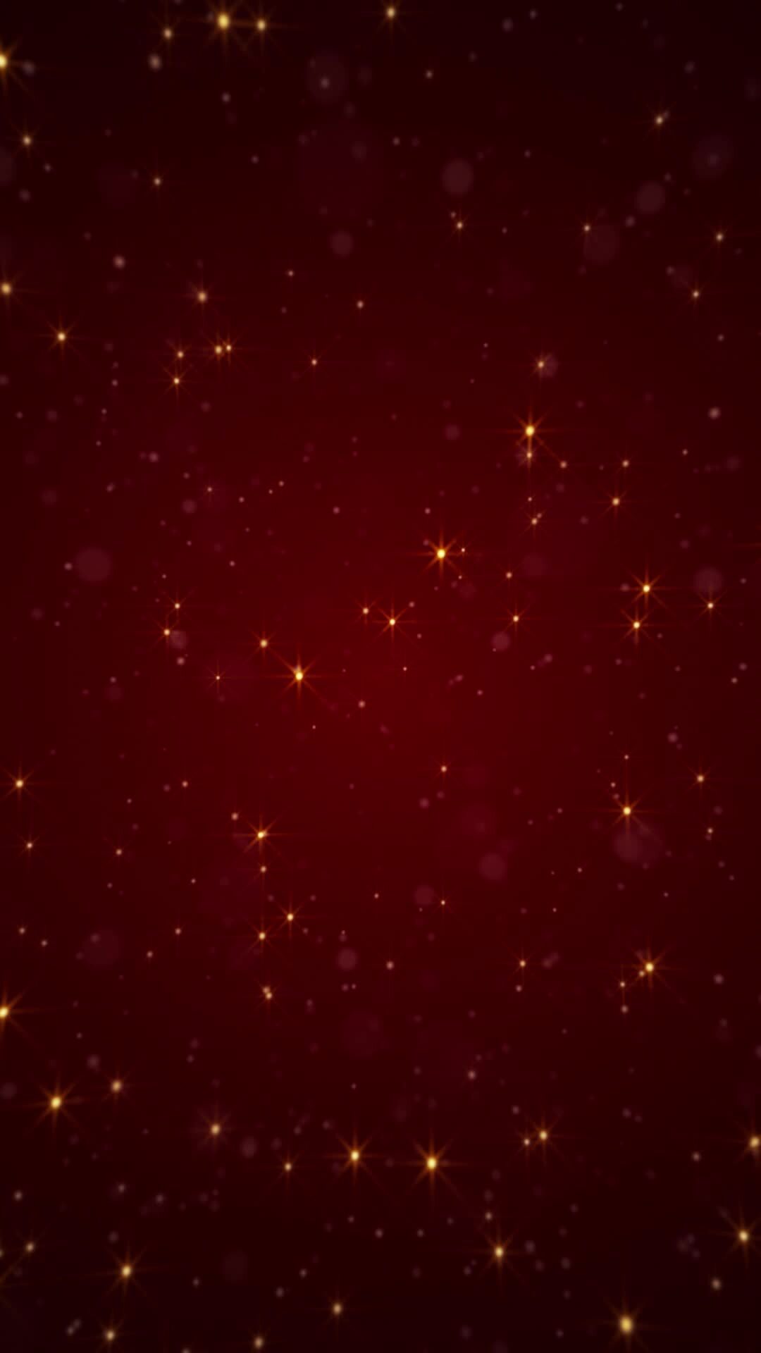 Vertical video - shiny twinkling golden stars and bokeh particles on a dark red gradient. This ...