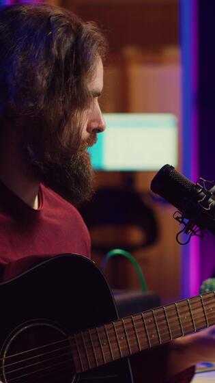 Vertical Video Artist with condenser microphone composing a song on ... Vertical Video Artist with condenser microphone composing a song on ...