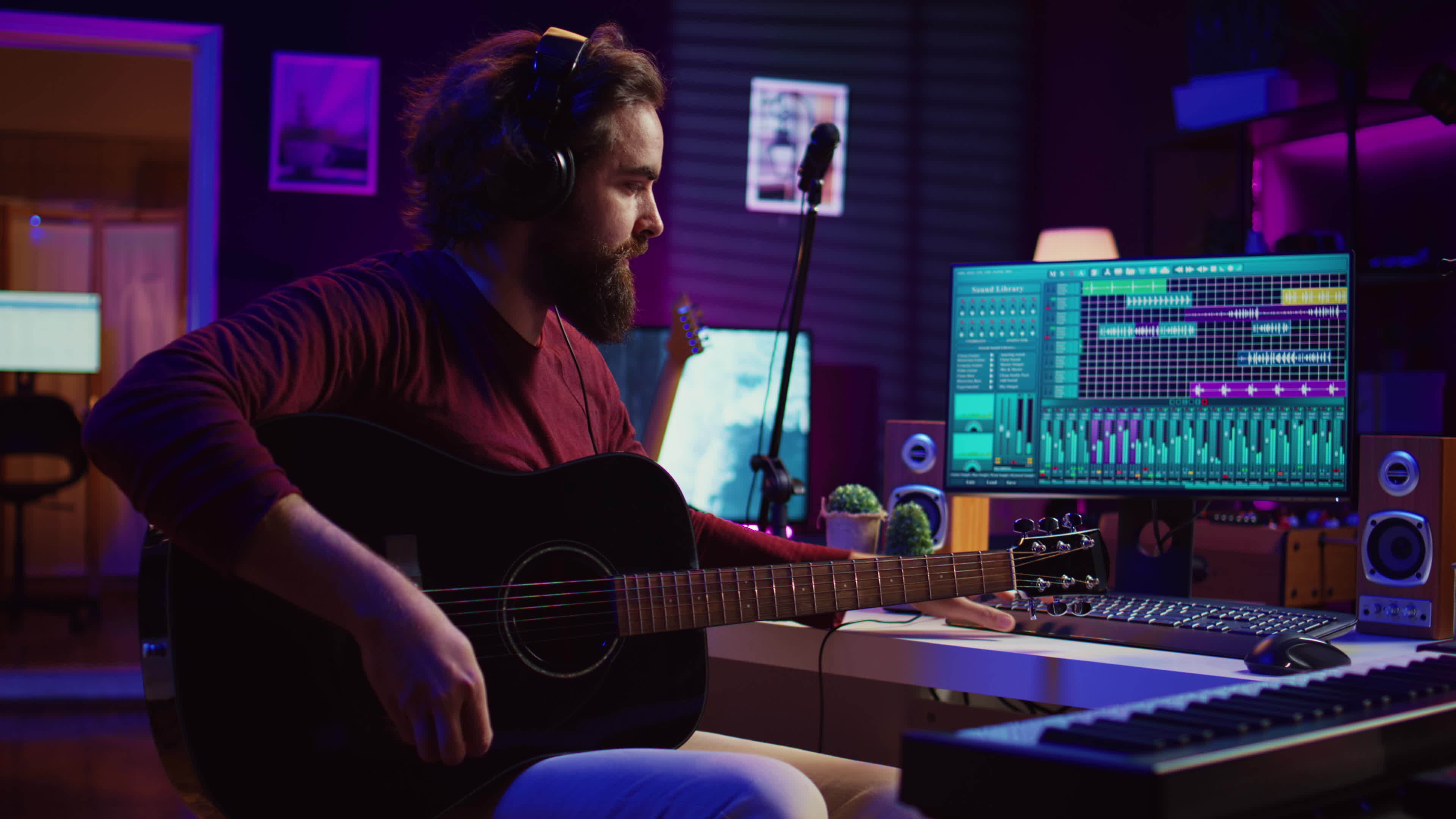 Sound Engineer Playing Acoustic Guitar And Using Mixing Console To