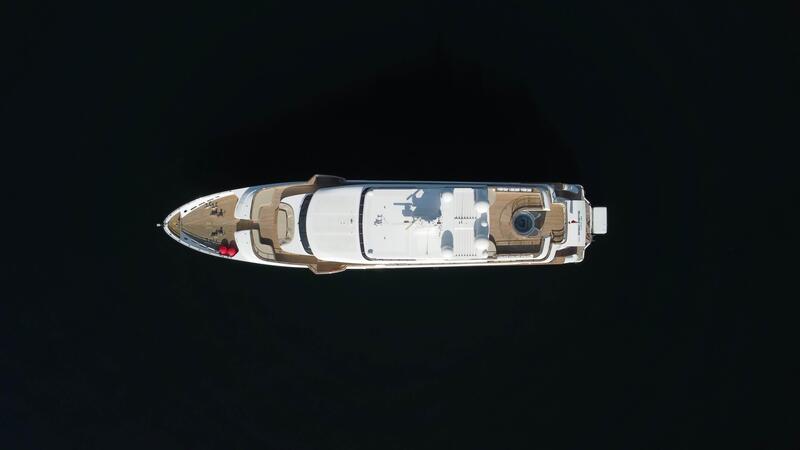 Aerial - Top down view of catching luxury motor boat racing on the ... Aerial - Top down view of catching luxury motor boat racing on the ...