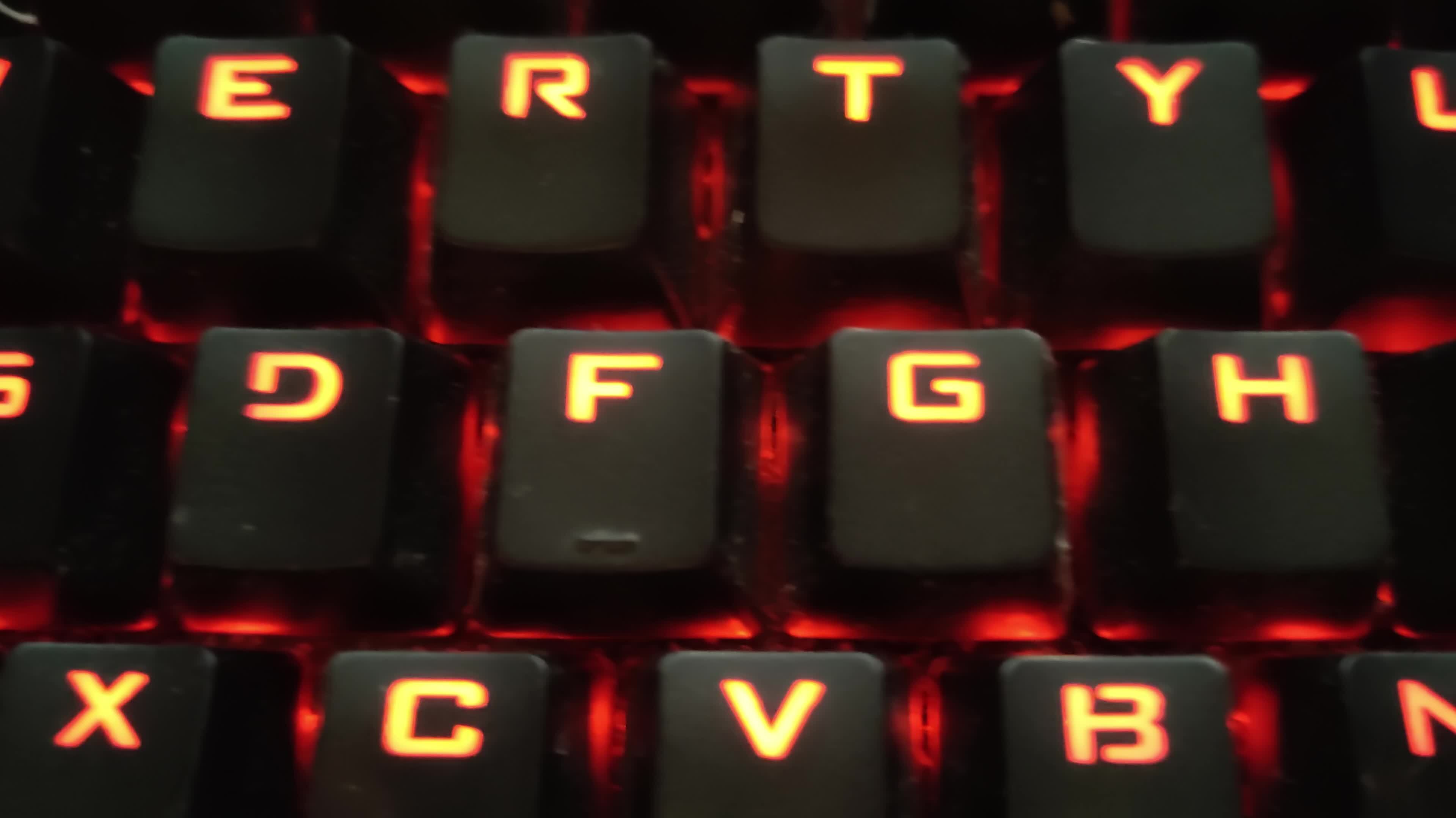 Backlit keyboard close up Black keys with illuminated characters ...