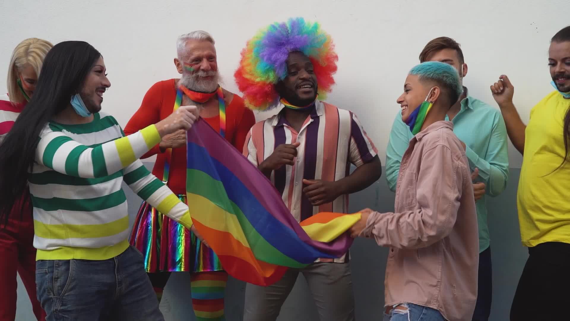 a group of people holding a rainbow flag 41478514 Stock Video at Vecteezy