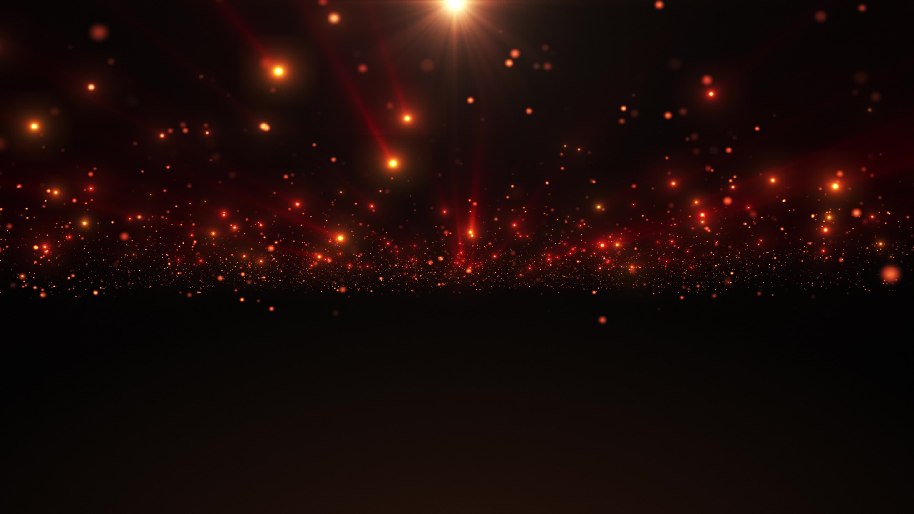 Abstract colorful background with bright gold or orange glowing flying particles emitting rays ...