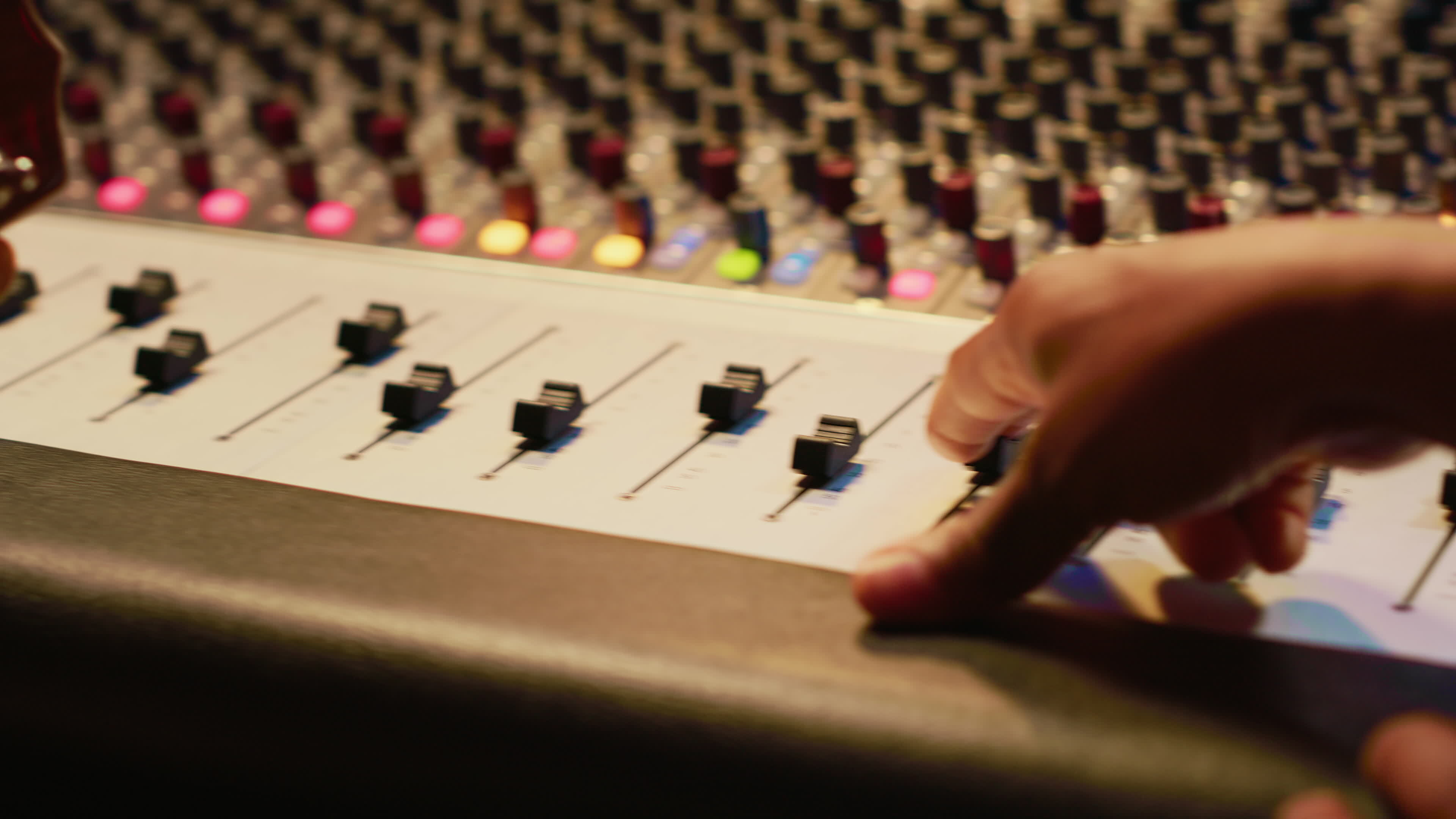 Artist composer creating a new song on his electro guitar in studio, recording tracks in control ...