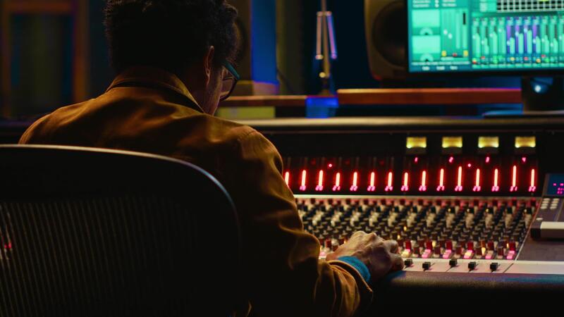African American Audio Engineer Using Sound Mixing Console For Managing