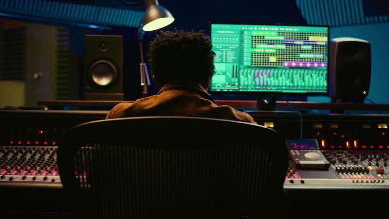 African American Audio Engineer Using Sound Mixing Console For Managing