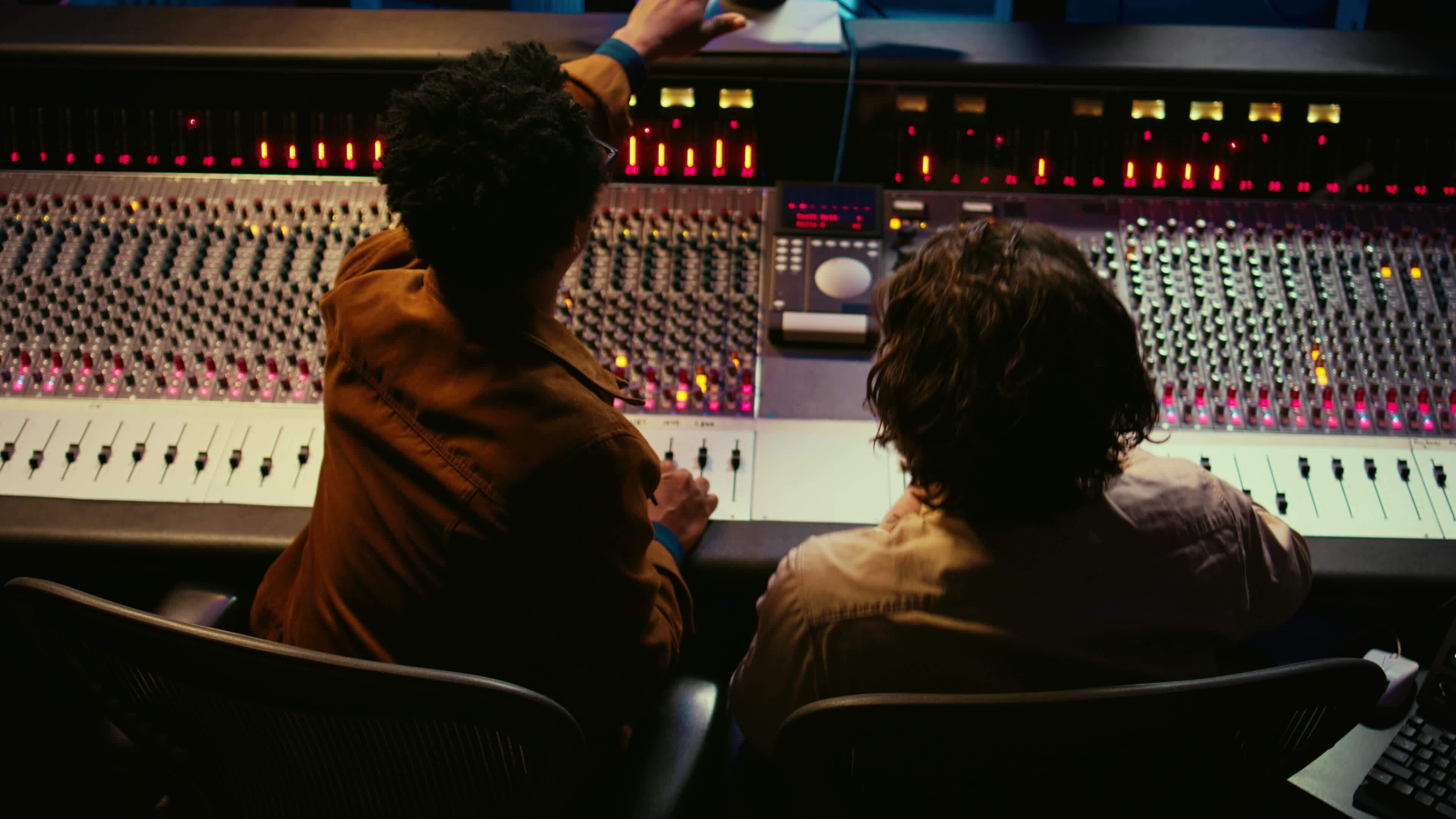 Team Of Sound Engineers Working On Recording And Editing Tracks In