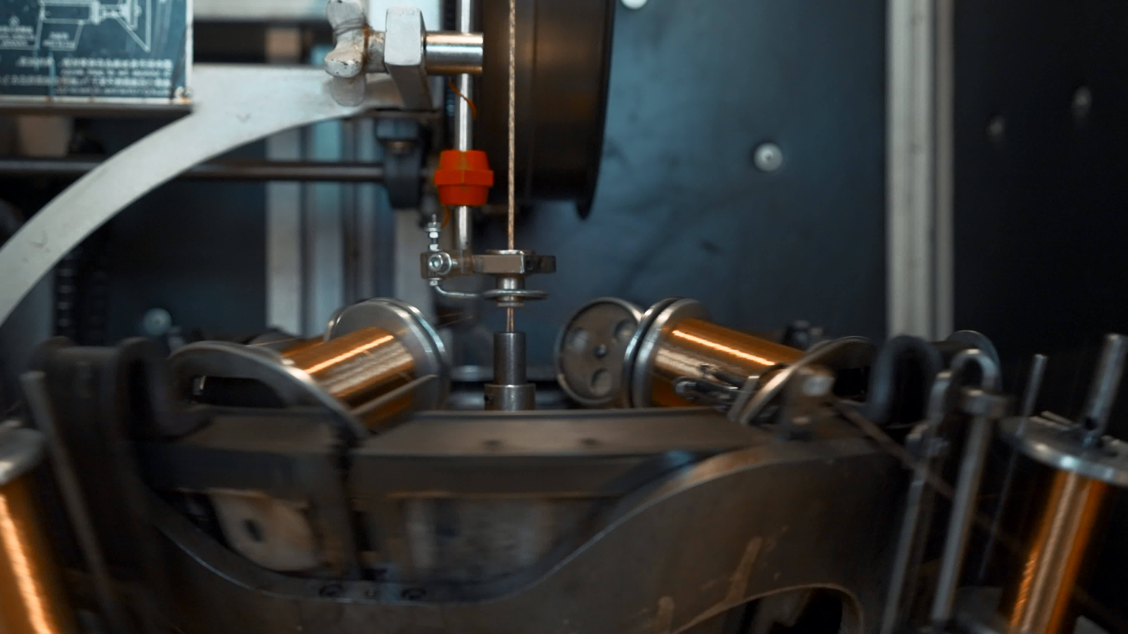 Automated machine with rotating coils and wire. Creative. Coils rotate on stack with winding ...