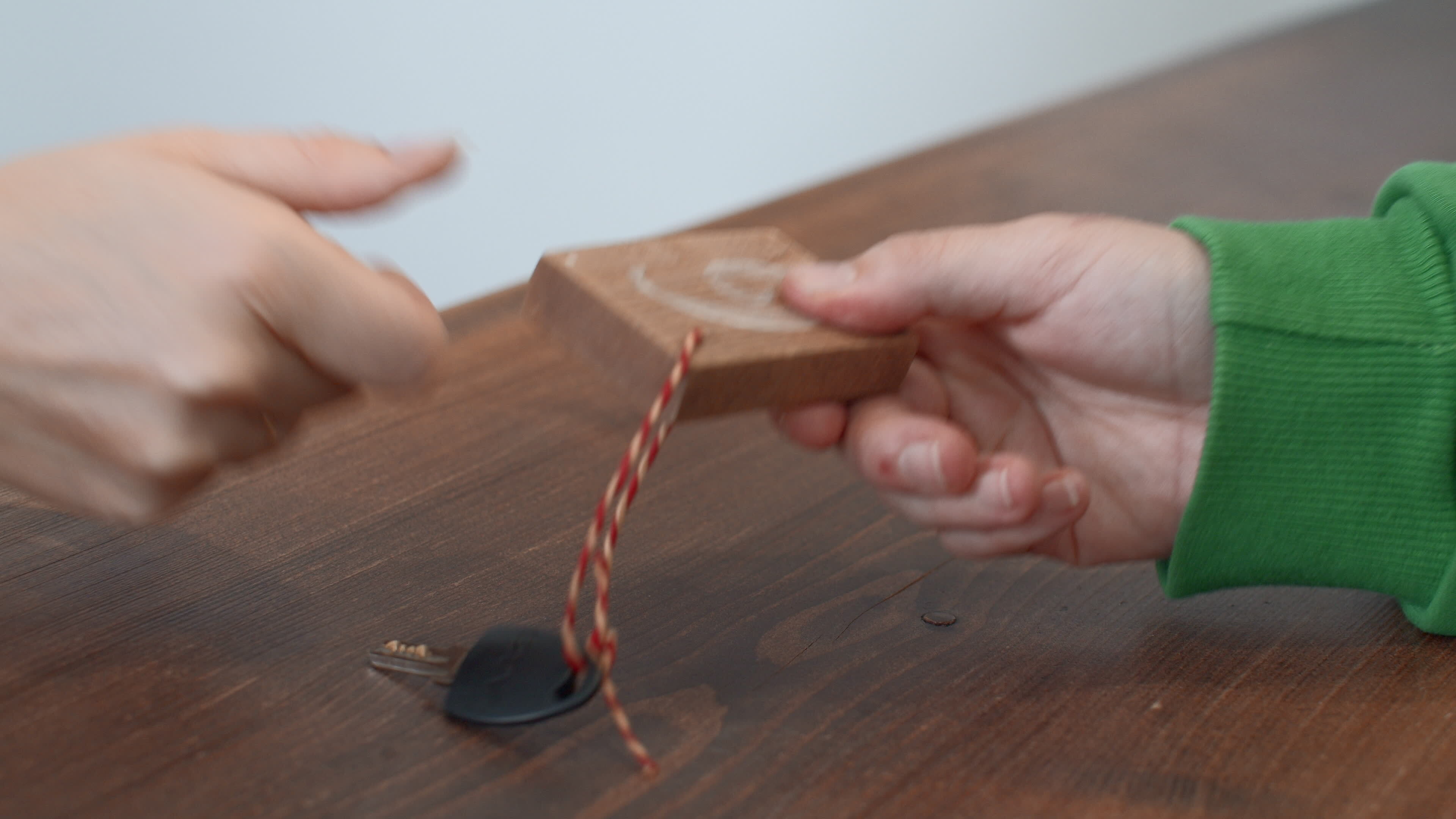 Passing small key with wooden number of a locker. Media. Close up of ...