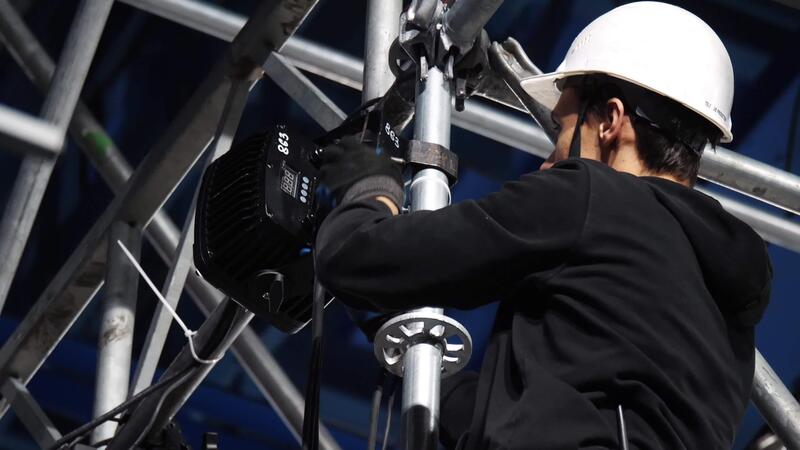 Close up of lighting technician installing professional lighting ...