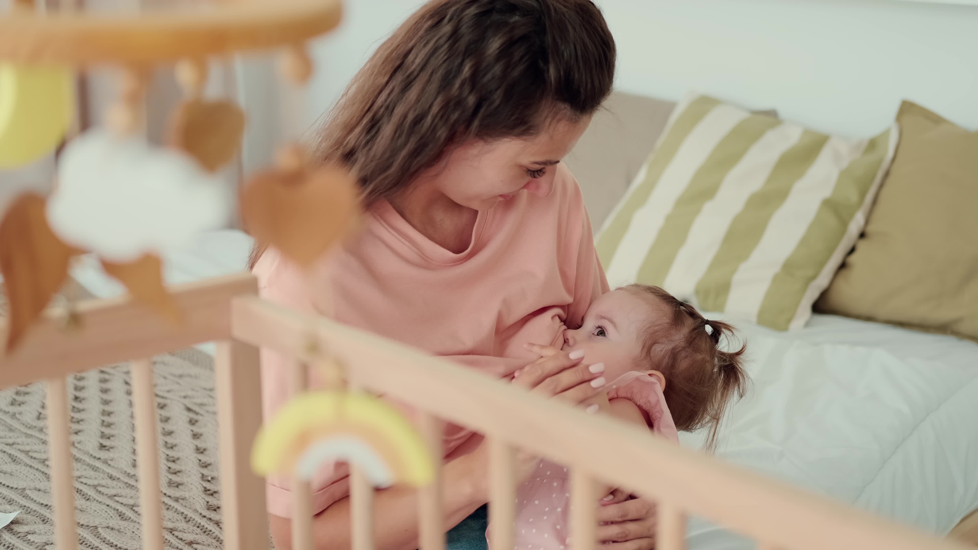 Childcare at Home, Child Protection, New Life, Leisure with Baby. Caring mom breastfeeds her ...