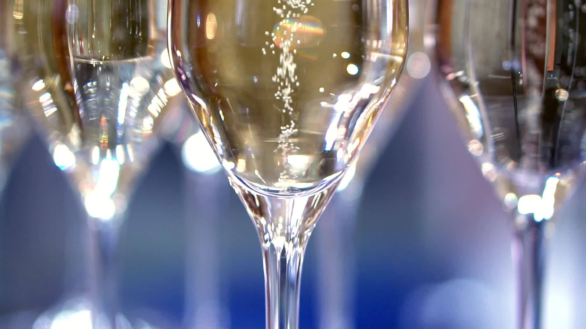 champagne in wine glasses. a sparkling wine. bubbles rise 42404682 Stock Video at Vecteezy