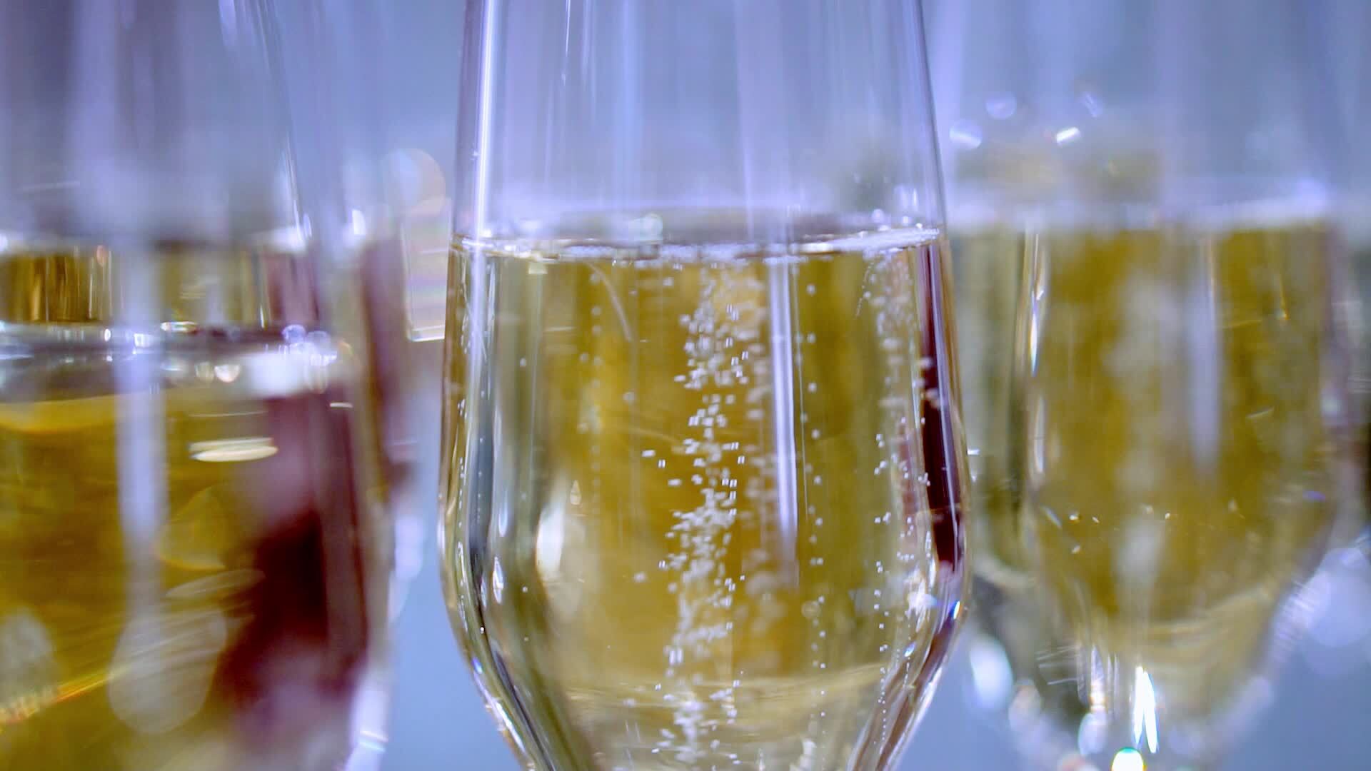 champagne in wine glasses. a sparkling wine. bubbles rise 42404683 Stock Video at Vecteezy