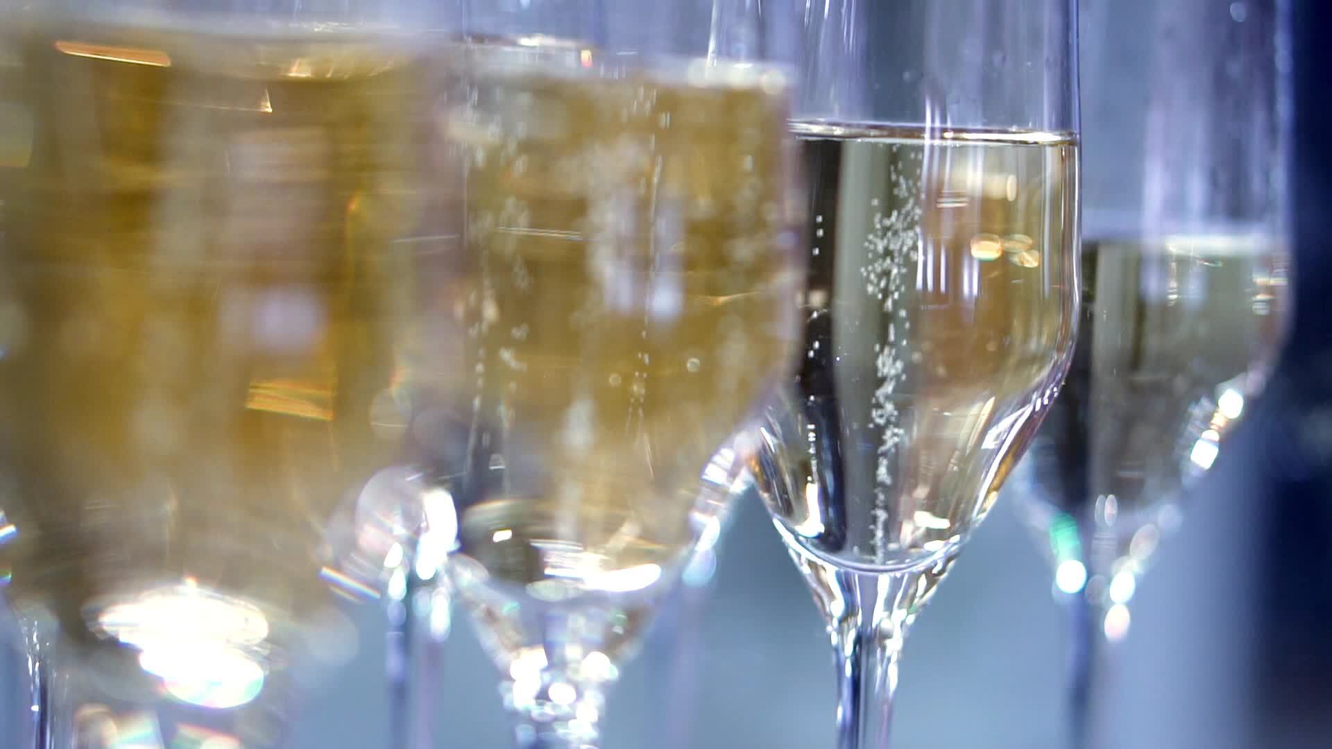 champagne in wine glasses. a sparkling wine. bubbles rise 42404684 Stock Video at Vecteezy