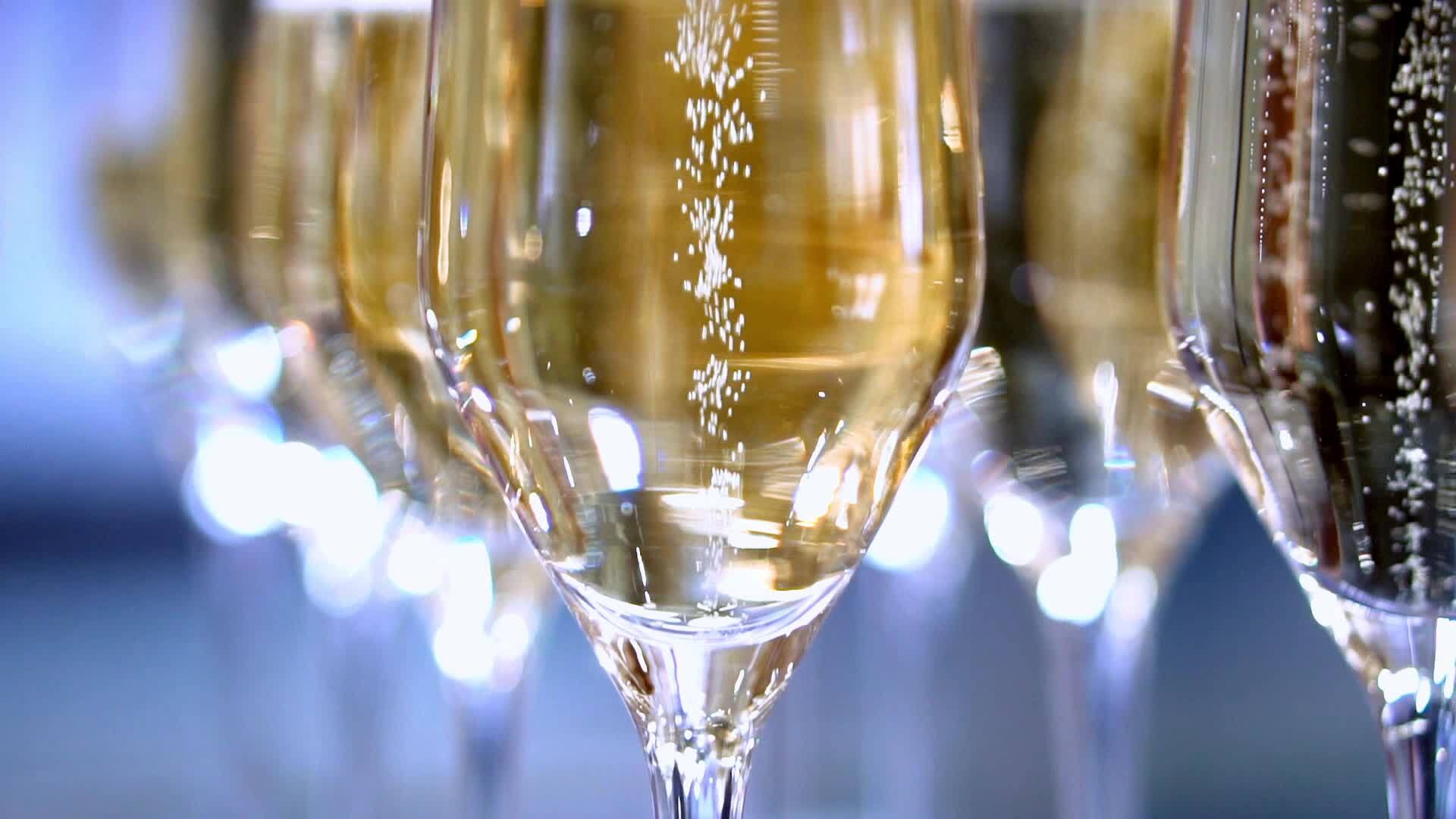 champagne in wine glasses. a sparkling wine. bubbles rise 42404699 Stock Video at Vecteezy
