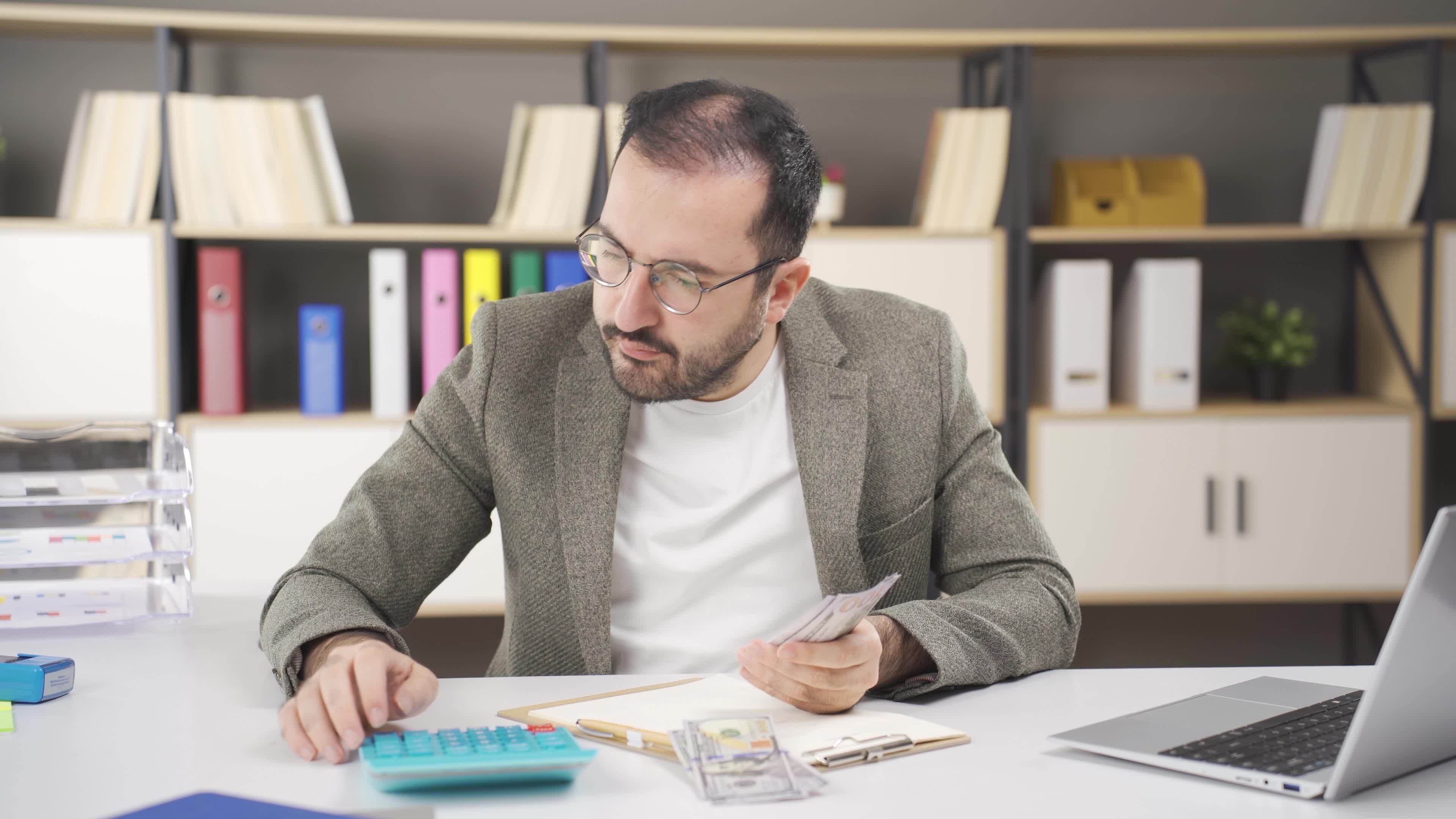 Office worker doing financial calculations. 42575053 Stock Video at ... Office worker doing financial calculations. 42575053 Stock Video at ...
