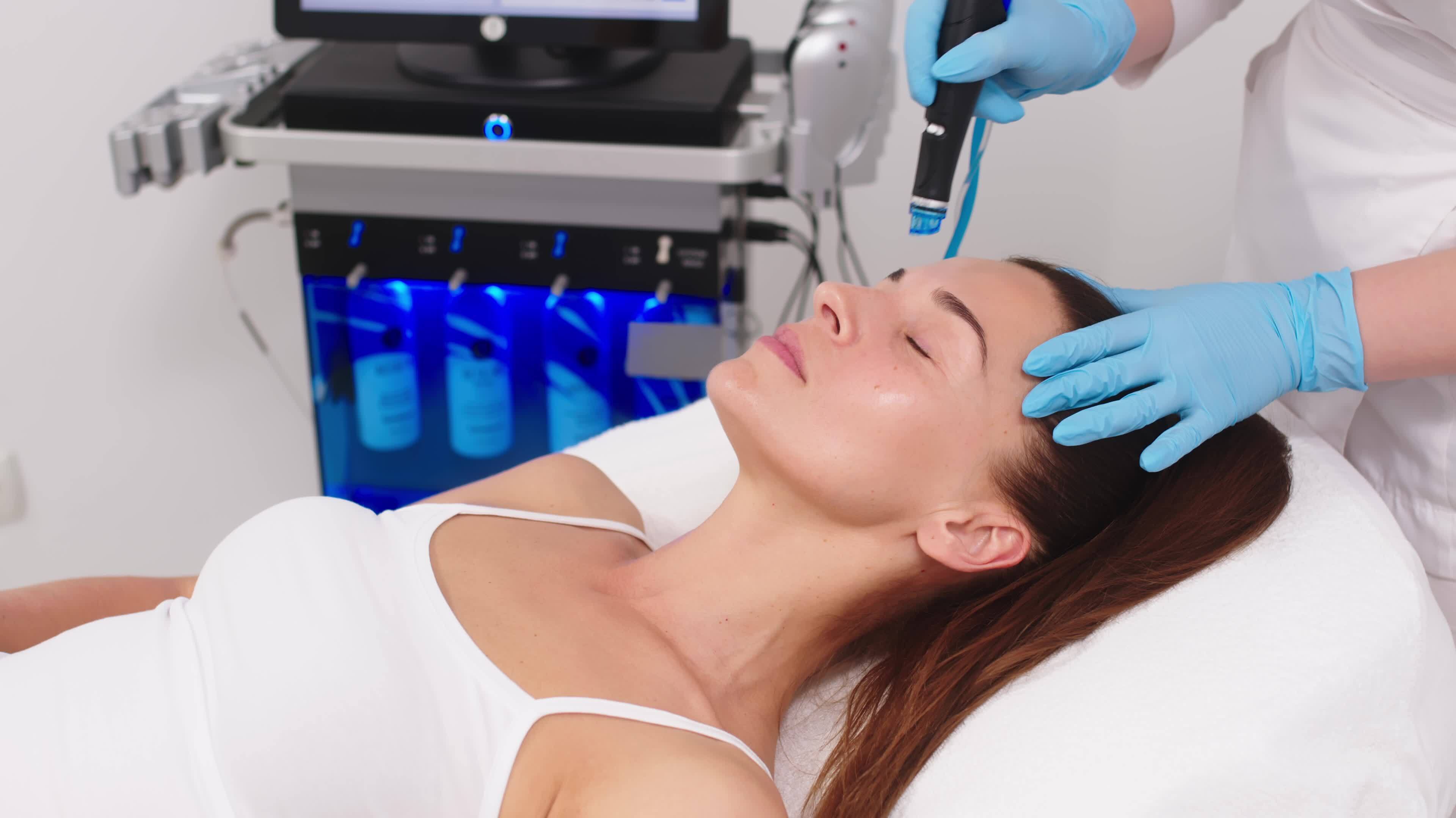 Middle aged woman receiving facial procedure of cleansing the skin ... Middle aged woman receiving facial procedure of cleansing the skin ...