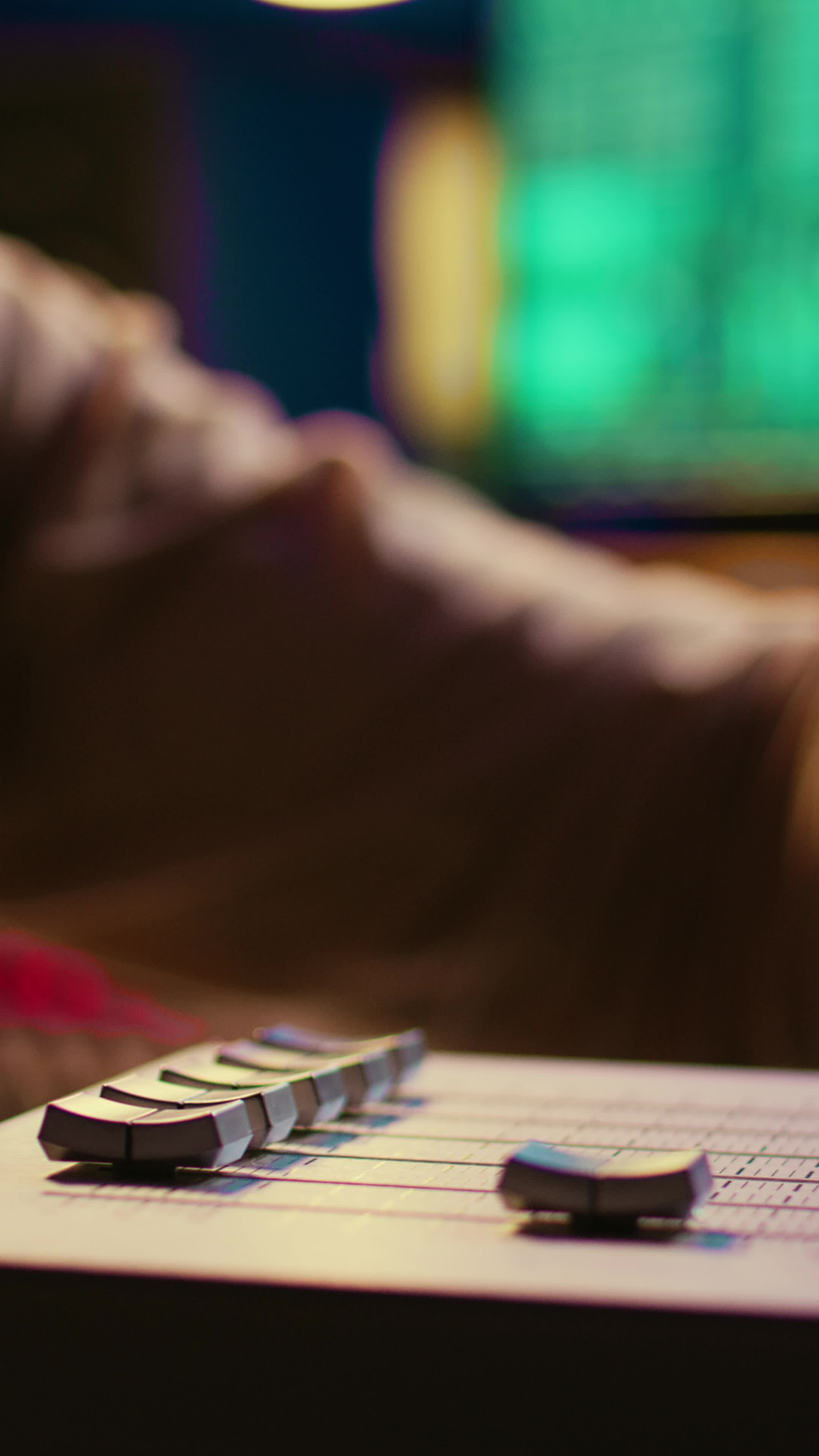 Vertical Sound Engineer Operating On Motorized Faders Controller In