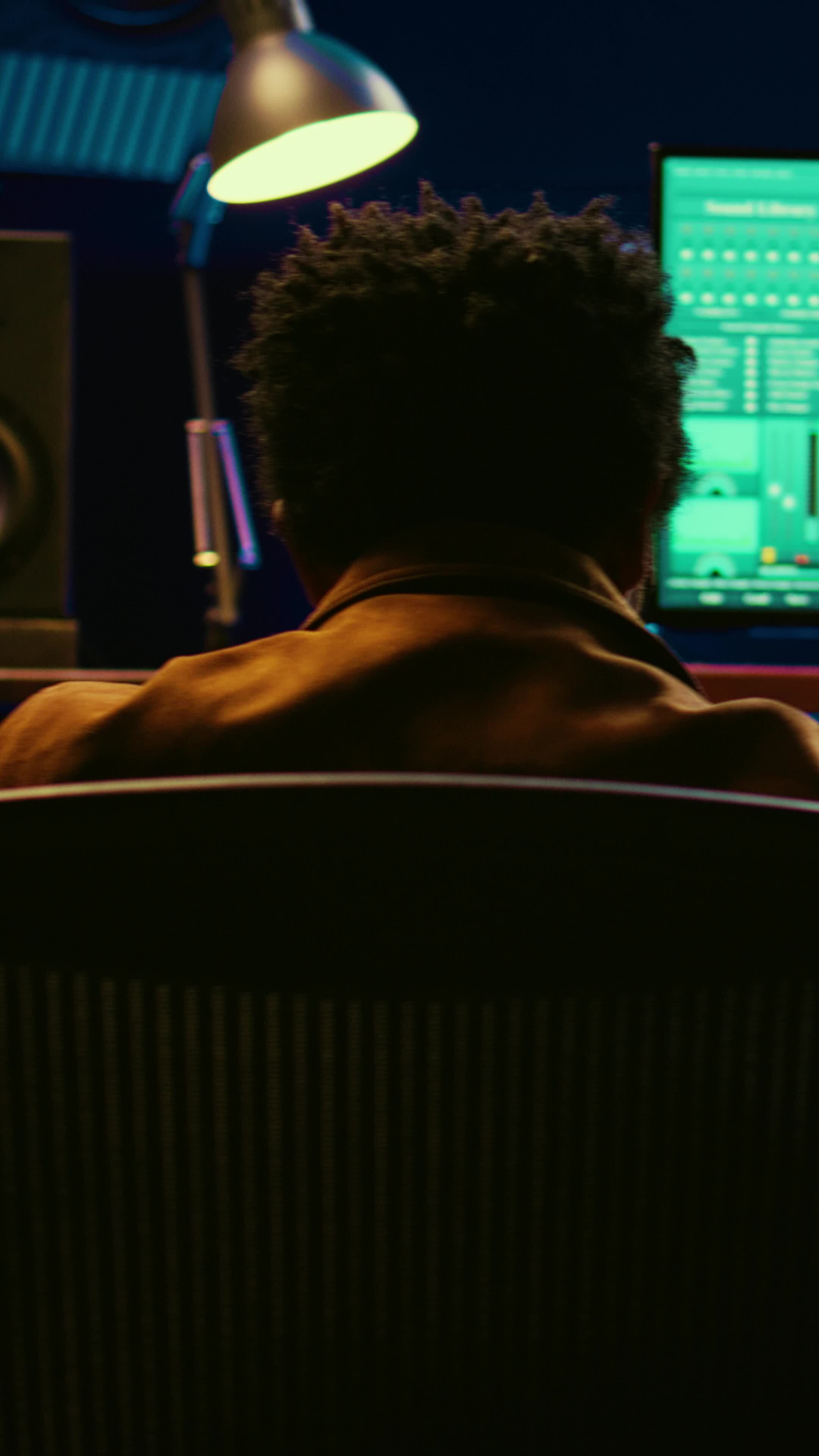 Vertical African American Audio Engineer Using Sound Mixing Console For
