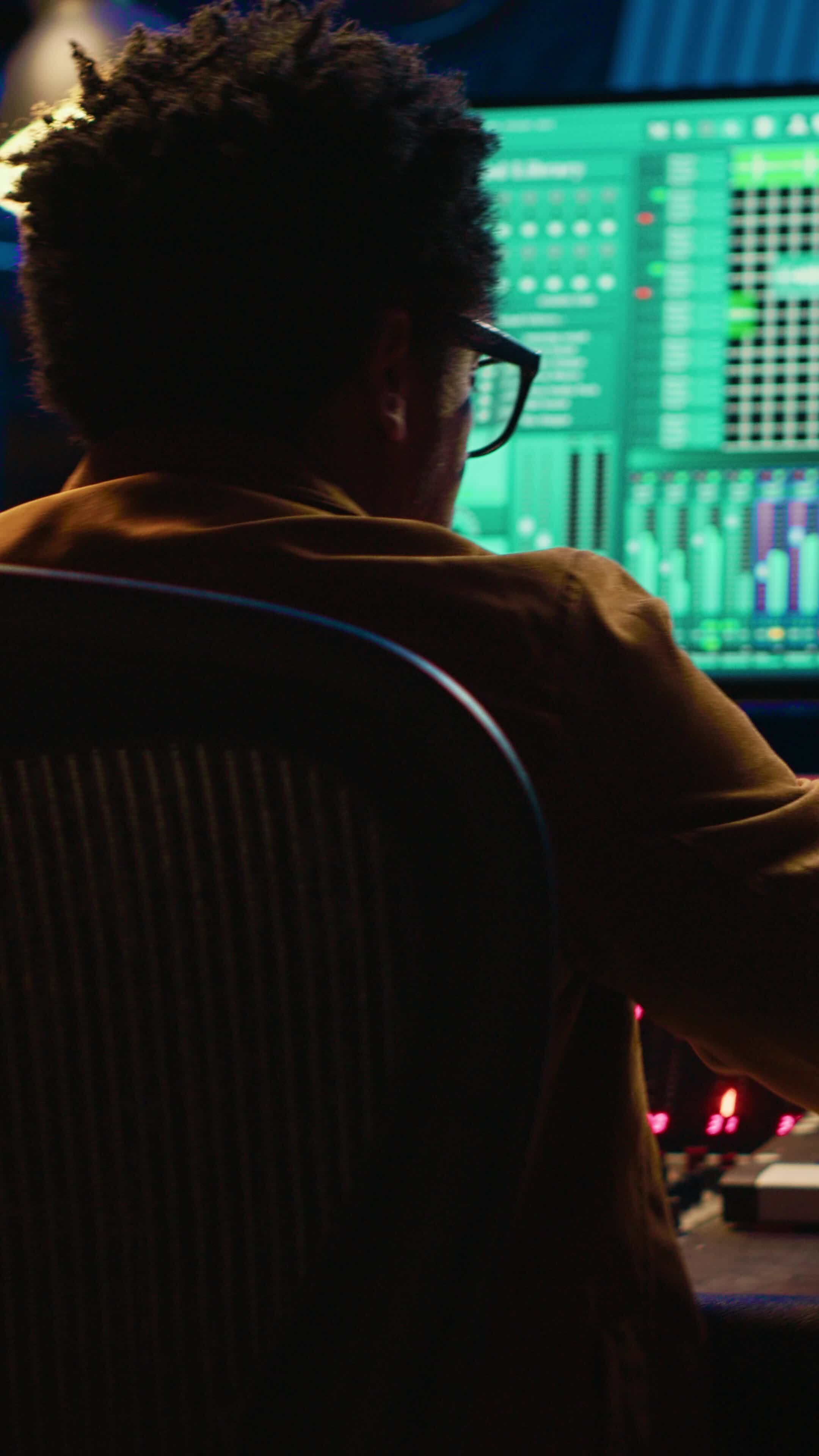 Vertical African American Sound Designer Editing Audio Recordings In