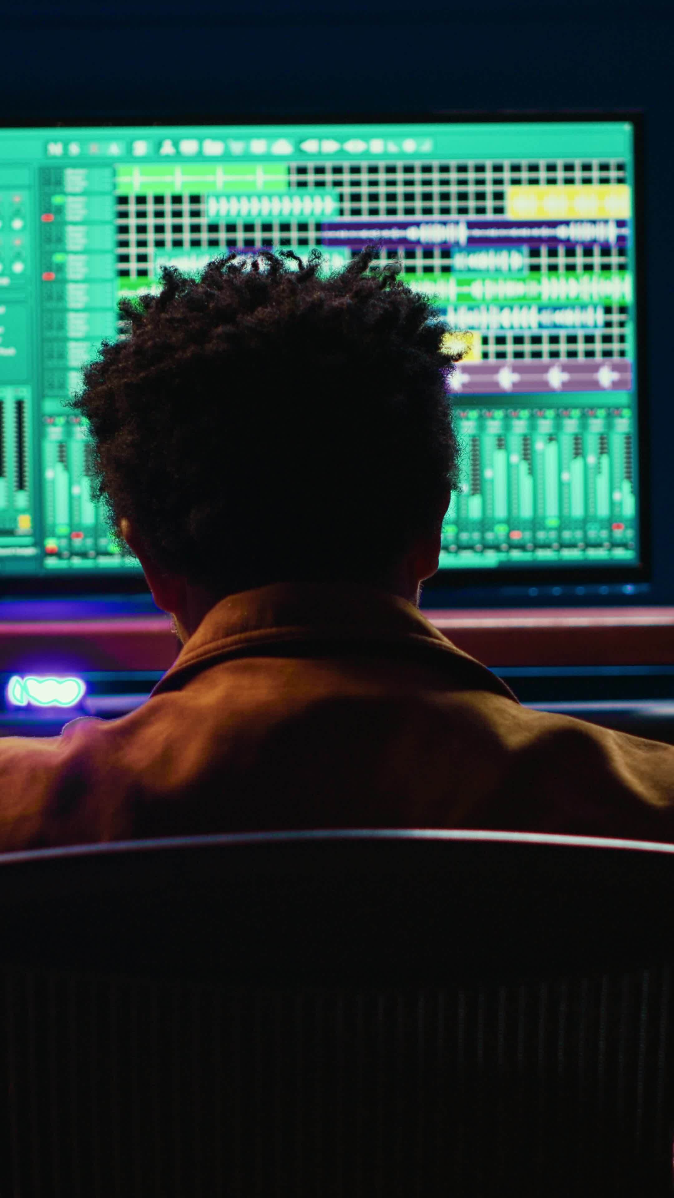 Vertical African American Sound Producer Editing Tracks On Audio