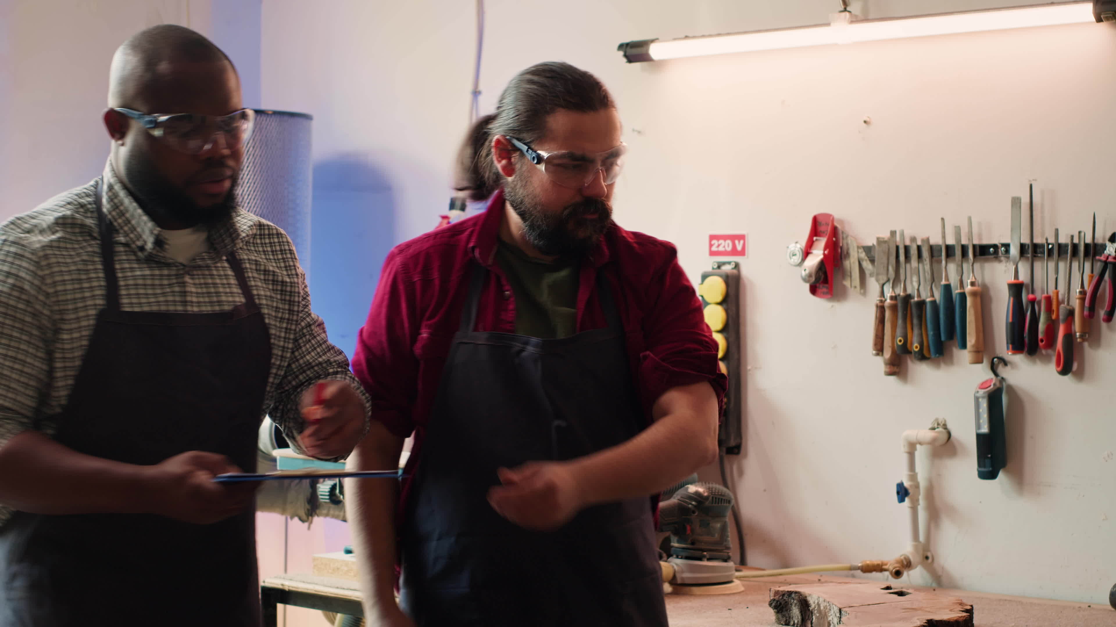 Carpenter making modifications on blueprint drawings, using angle ...