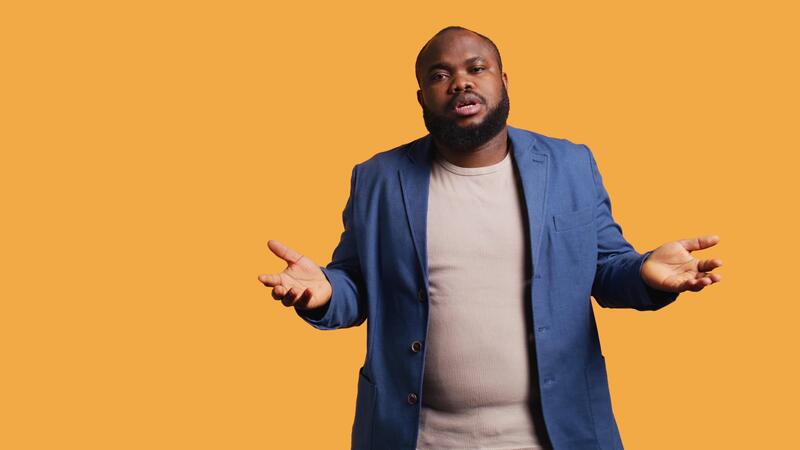 Uncaring man shrugs shoulders, showing indifference and apathy while ...