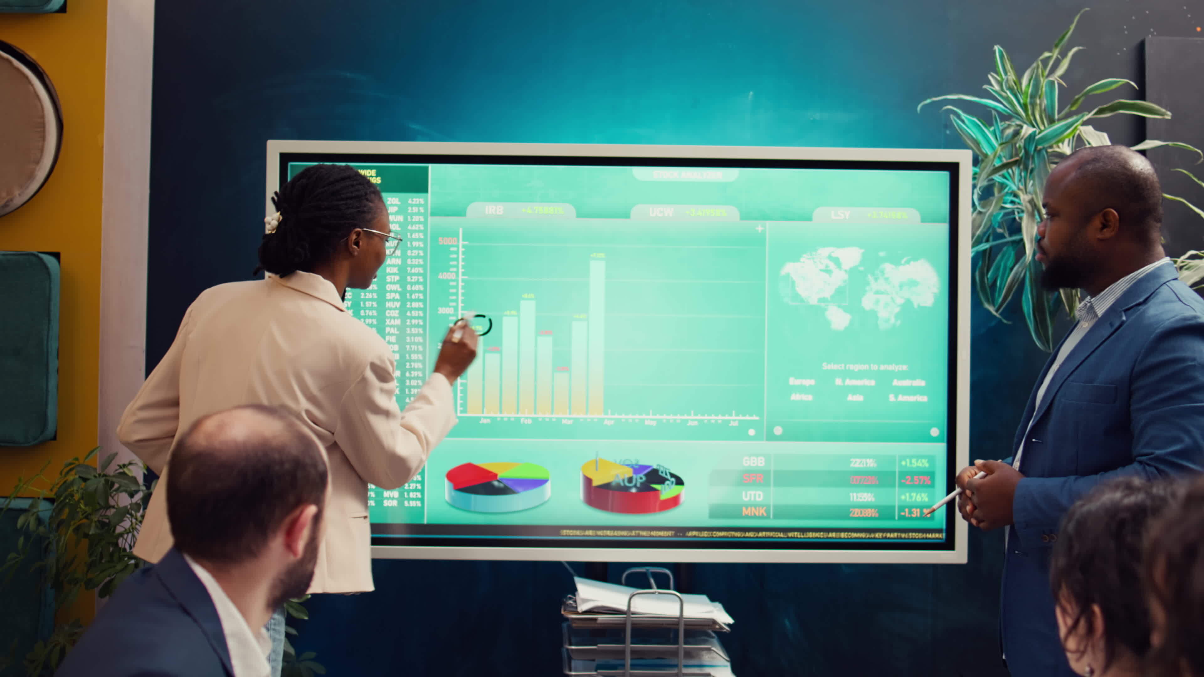 Financial analysts team evaluating market trends and infographics, reviewing business ...