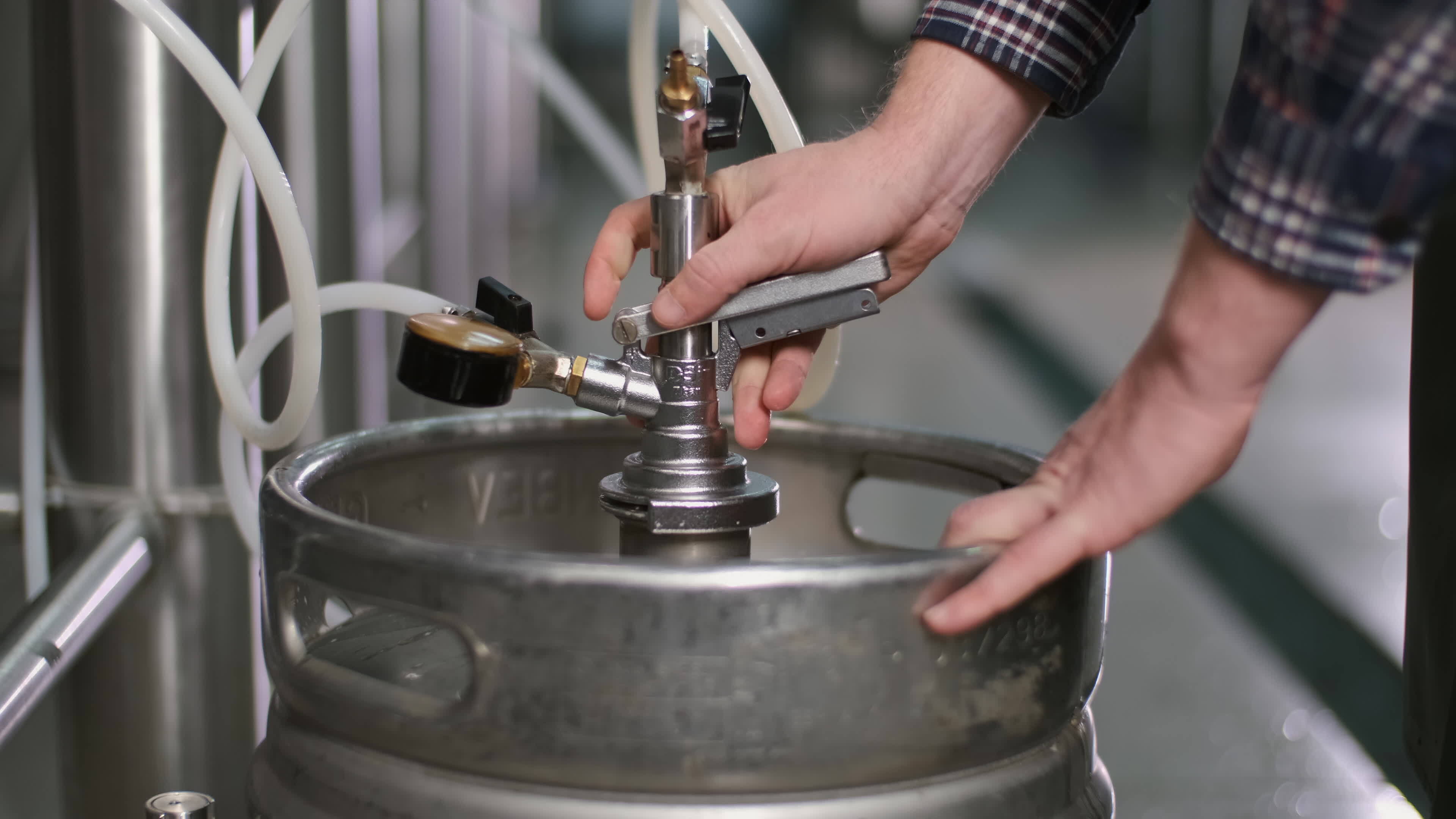 Male brewer connects a keg to a beer tank and fills it with beer. Close-up 4k 43244026 Stock ...