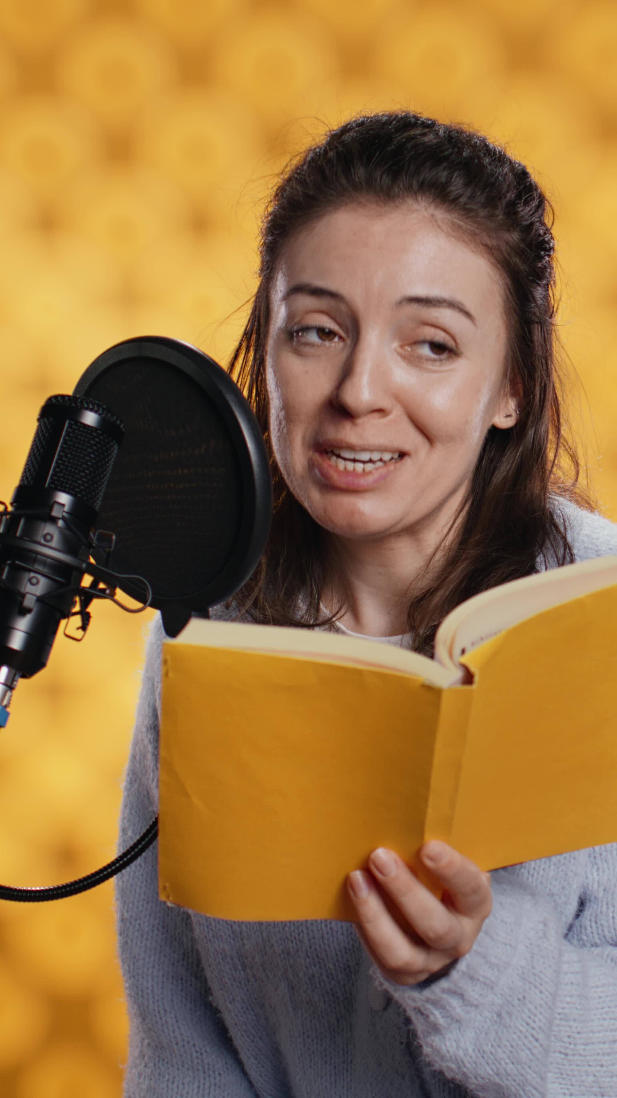 Vertical Media star filming vlog at work, reading book to record ...