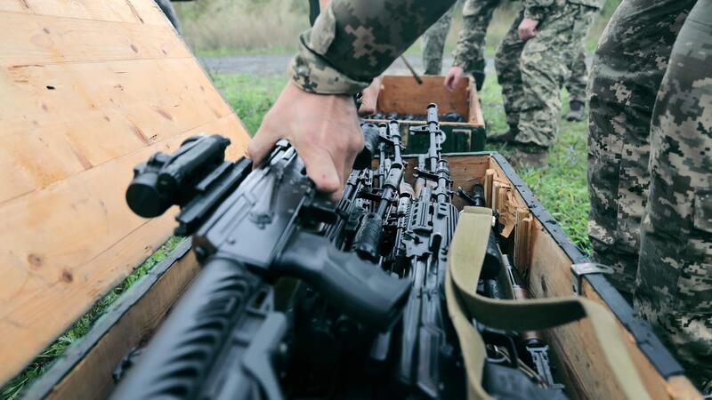 The military loads weapons into a box. After the military operation, the military assembles ...