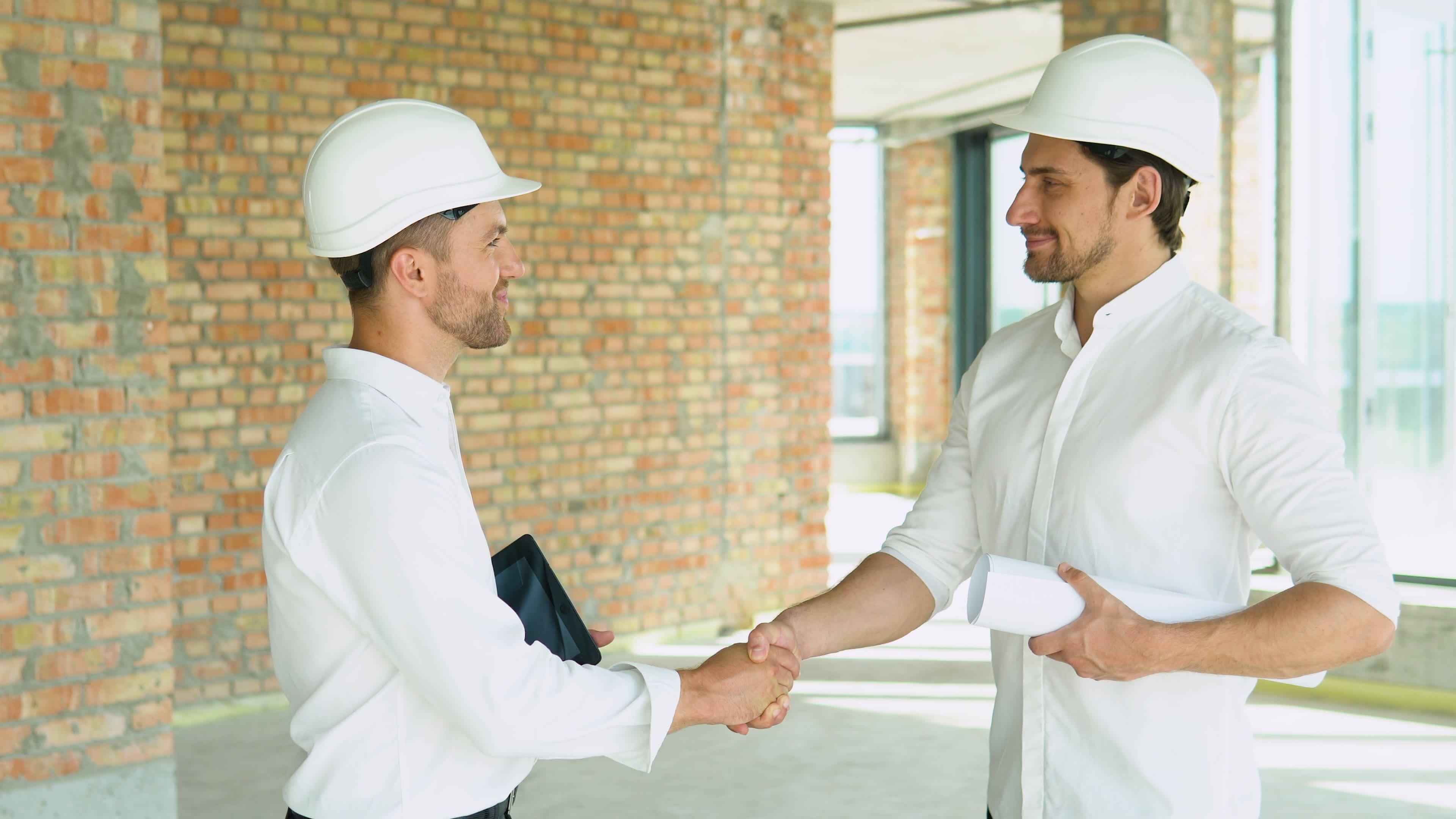 Close up of handshake in construction site. Friendly handshake of two ...