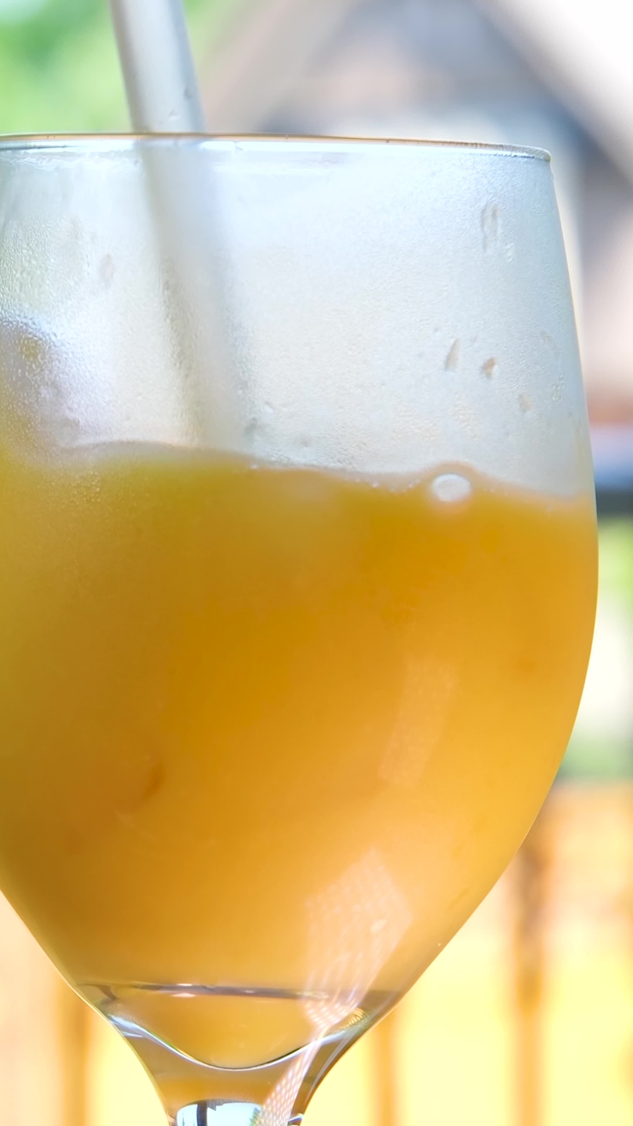 Orange juice pouring into ice cube glass rotated. Orange Juice Pouring Into Glass With Ice Cubes ...