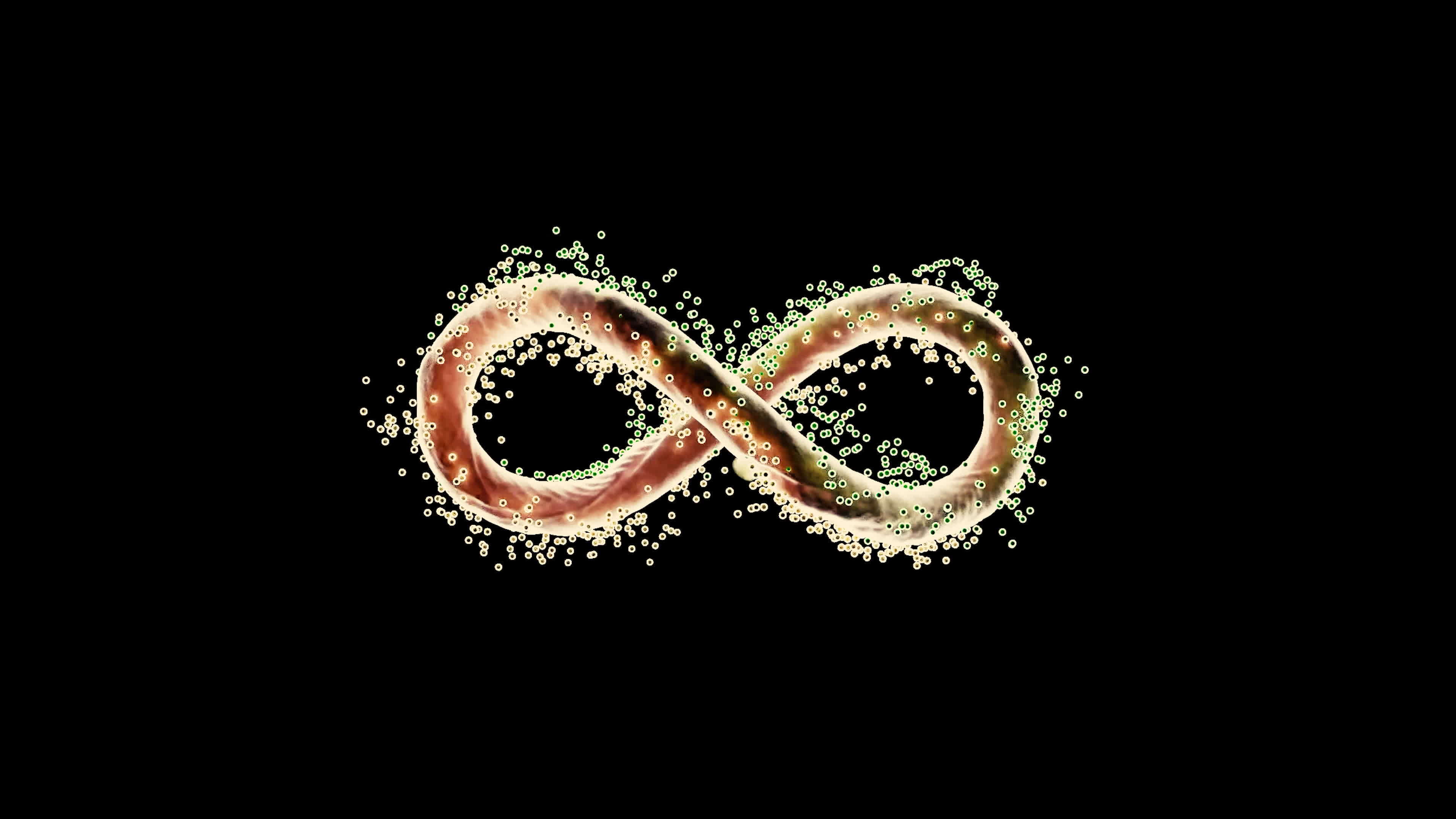 Infinity sign with the endless flowing energy isolated on a black background, seamless loop ...
