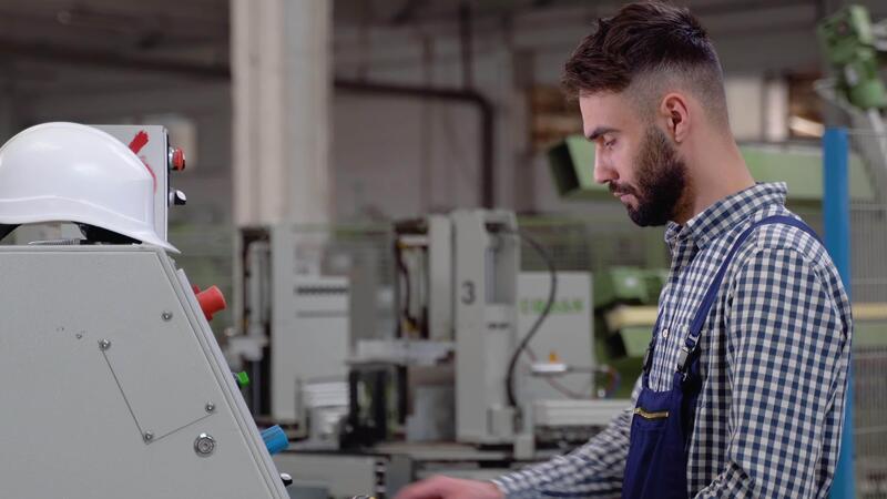 Industrial programmer checking control box status with computer ... Industrial programmer checking control box status with computer ...