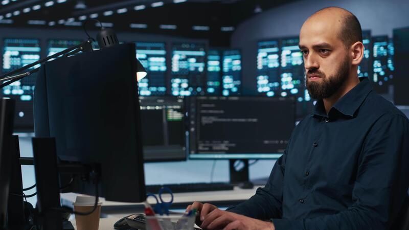 System administrator working in computer network security data center, ensuring optimal ...