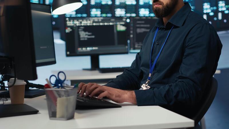 Proficient Technician Overseeing Server Room Running Code On Computer Troubleshooting Servers