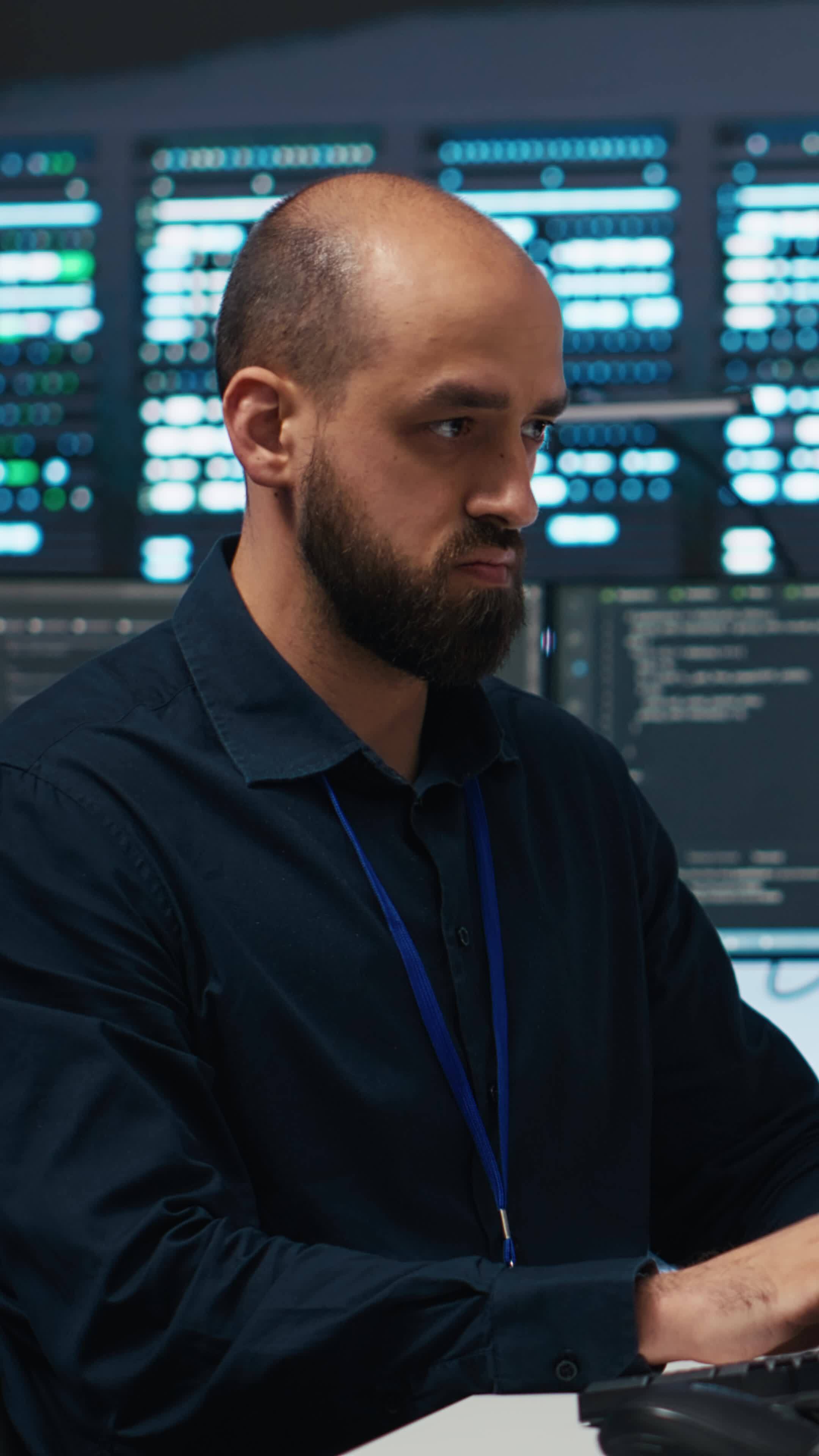 Vertical Technician using PC in high tech server hub facility to safeguard data from intruding ...