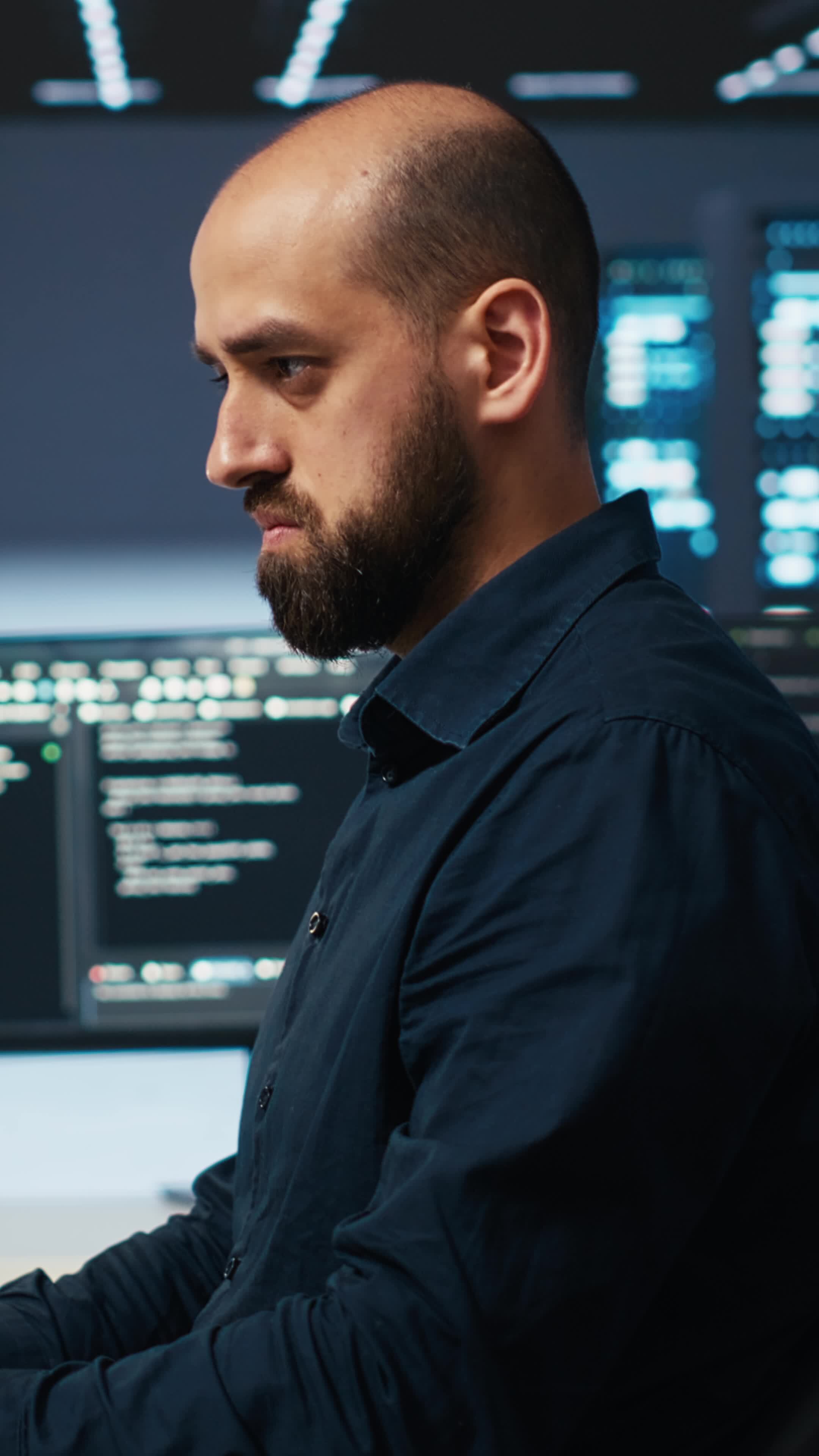 Vertical It Engineer Overseeing Server Room Running Code On Computer