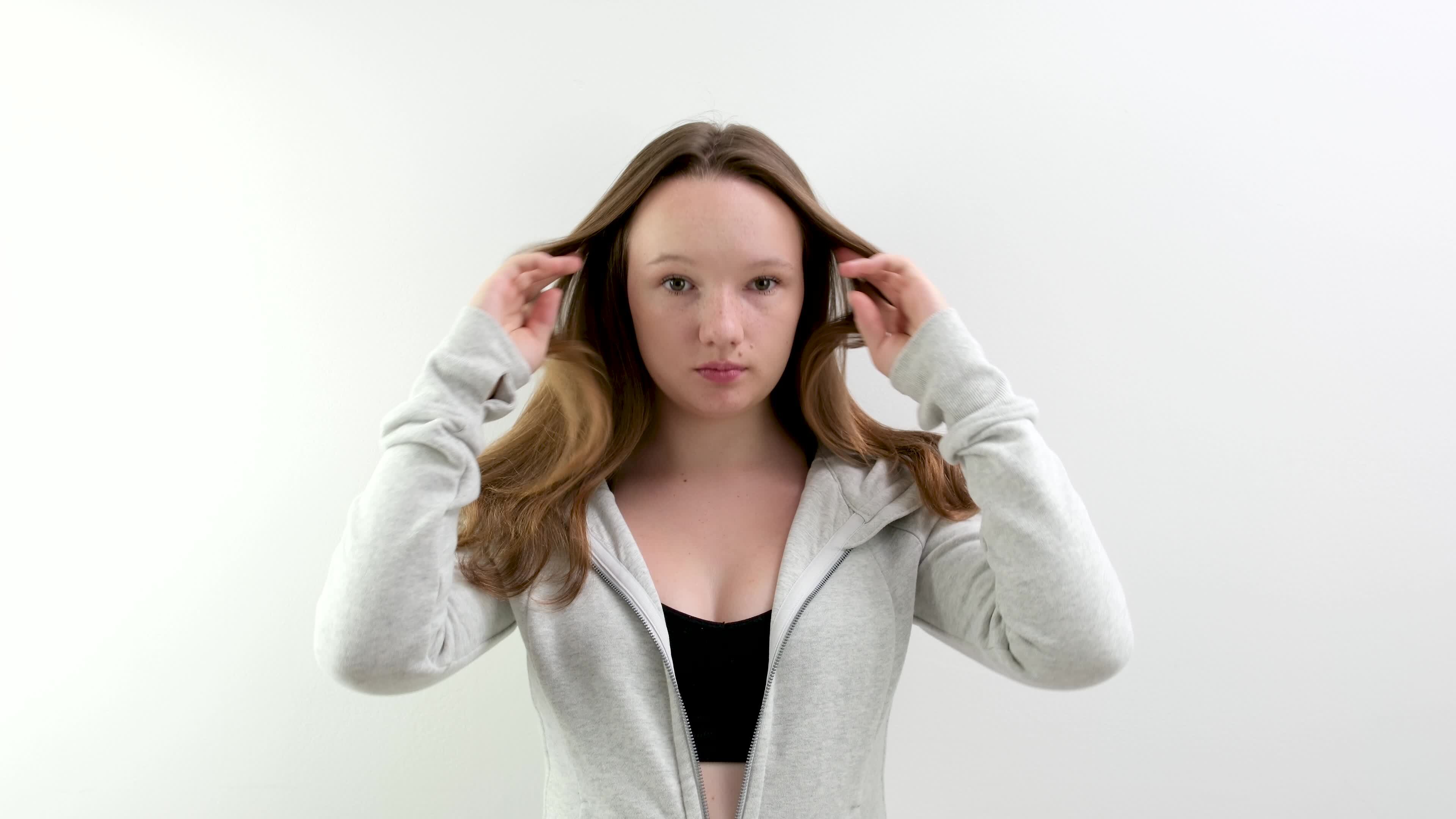 put on a sports outfit, a young teenage girl is preparing for sports, a black top and a gray ...