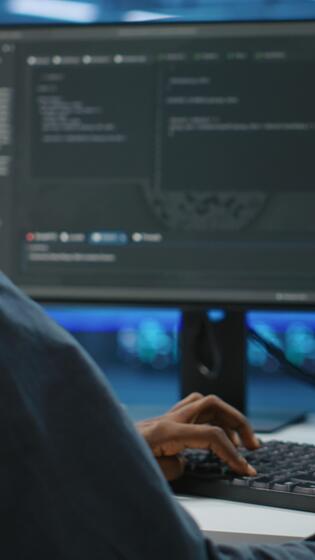 Vertical Technician doing system analysis, typing data on PC, doing needed adjustments in ...