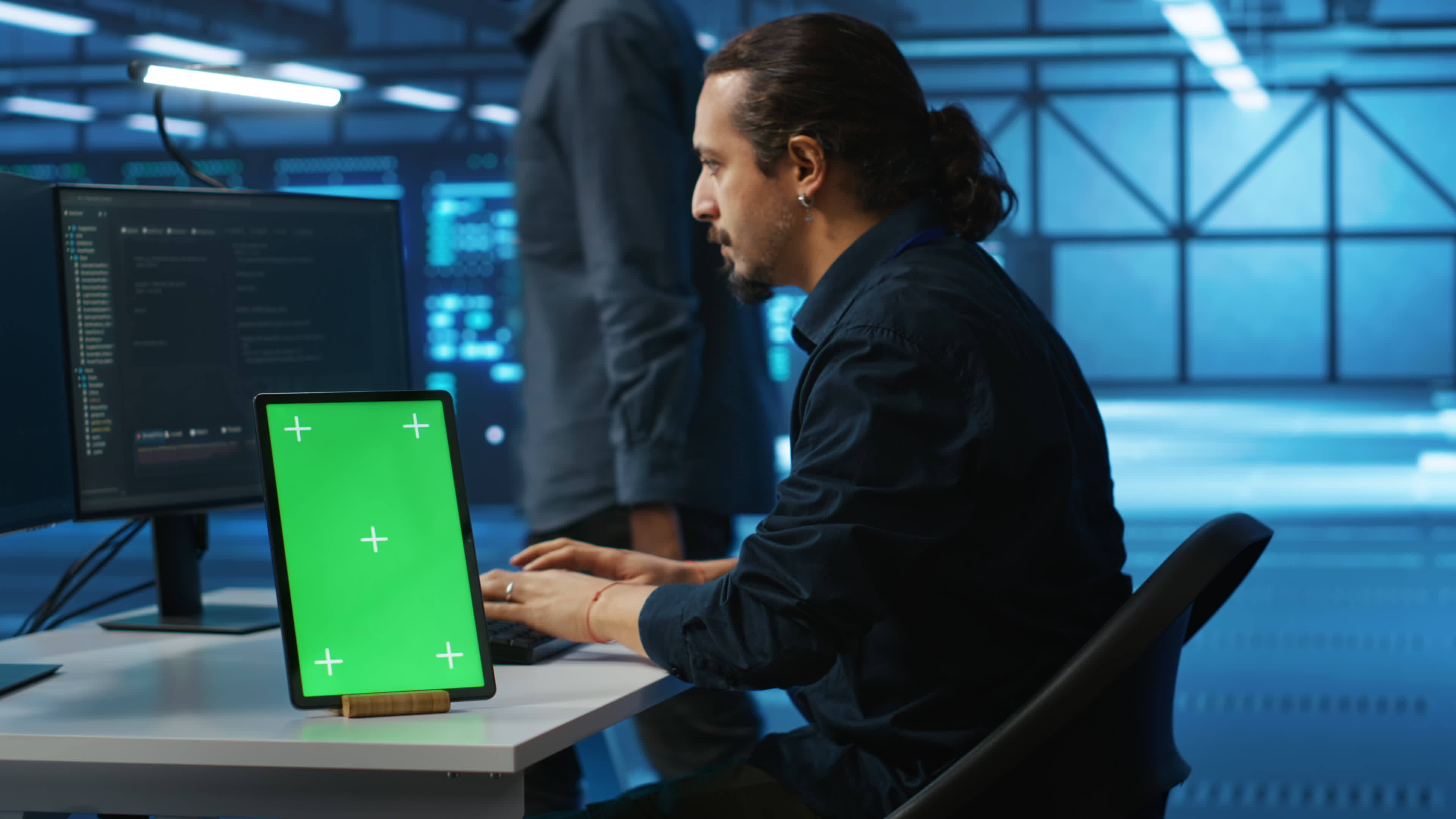 Man upgrading equipment in data center using isolated screen tablet. IT ...