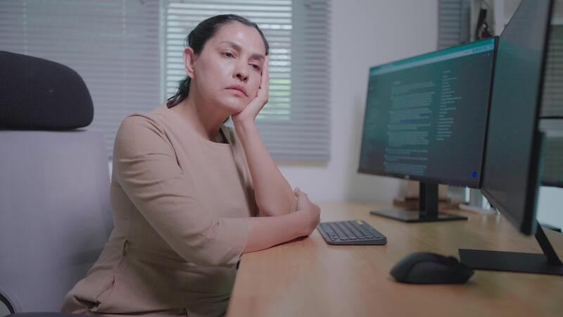 Freelance career woman sitting writing code discouraged tired code ... Freelance career woman sitting writing code discouraged tired code ...
