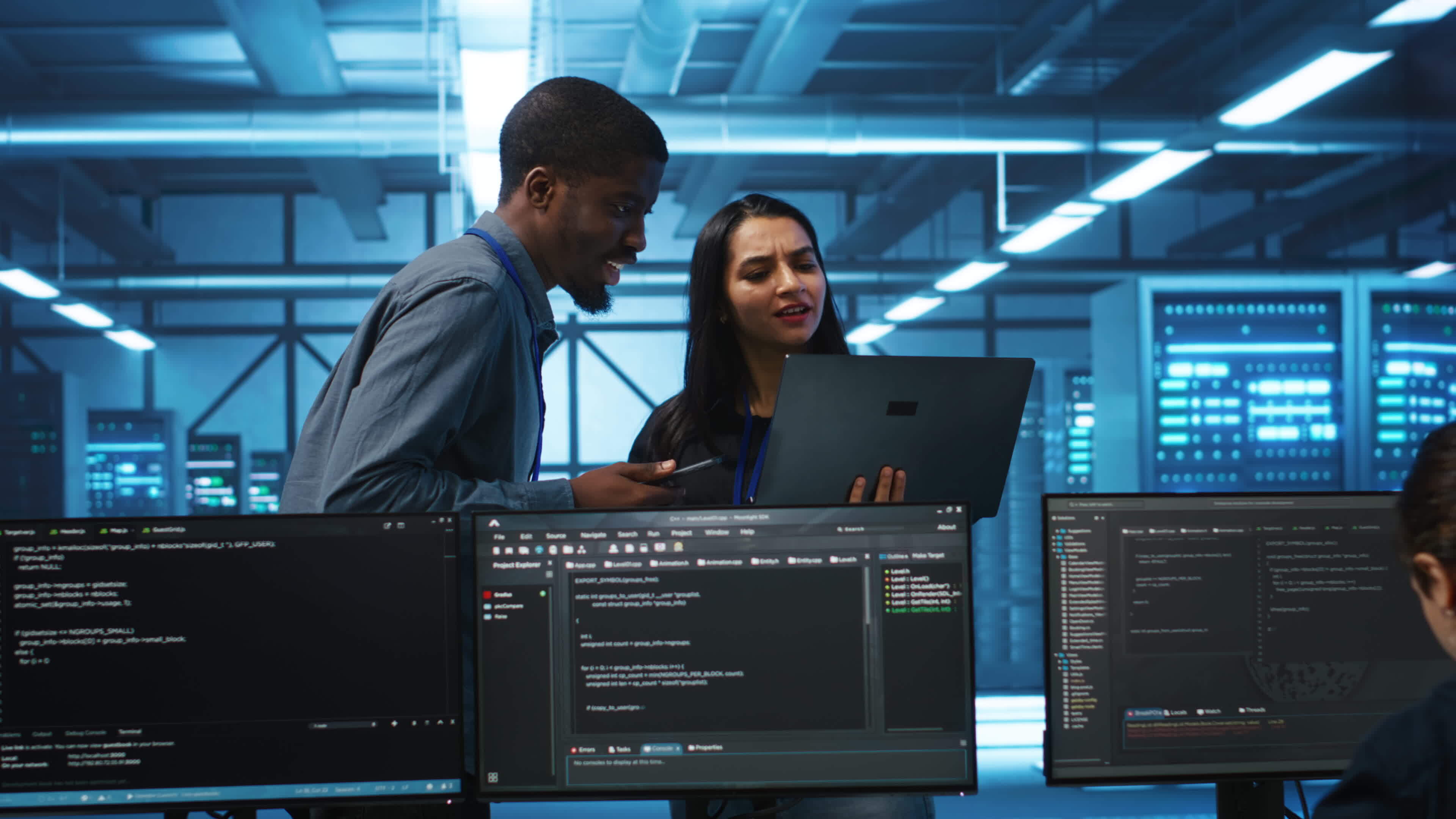 Technician and team leader in server farm looking for equipment misconfigurations affecting ...