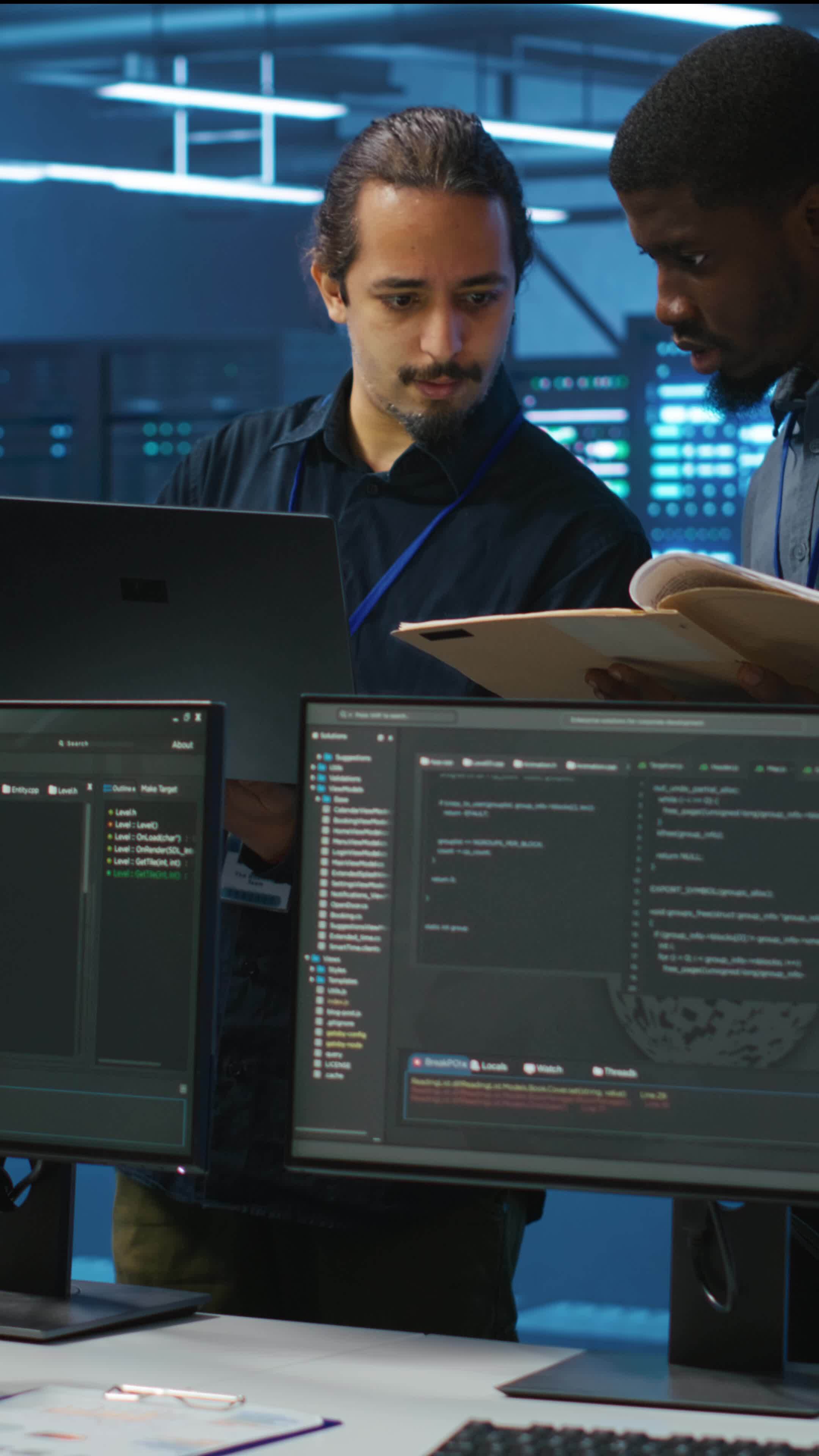 Vertical Man inspecting server farm, reading paperwork, following inspection checklist, talking ...